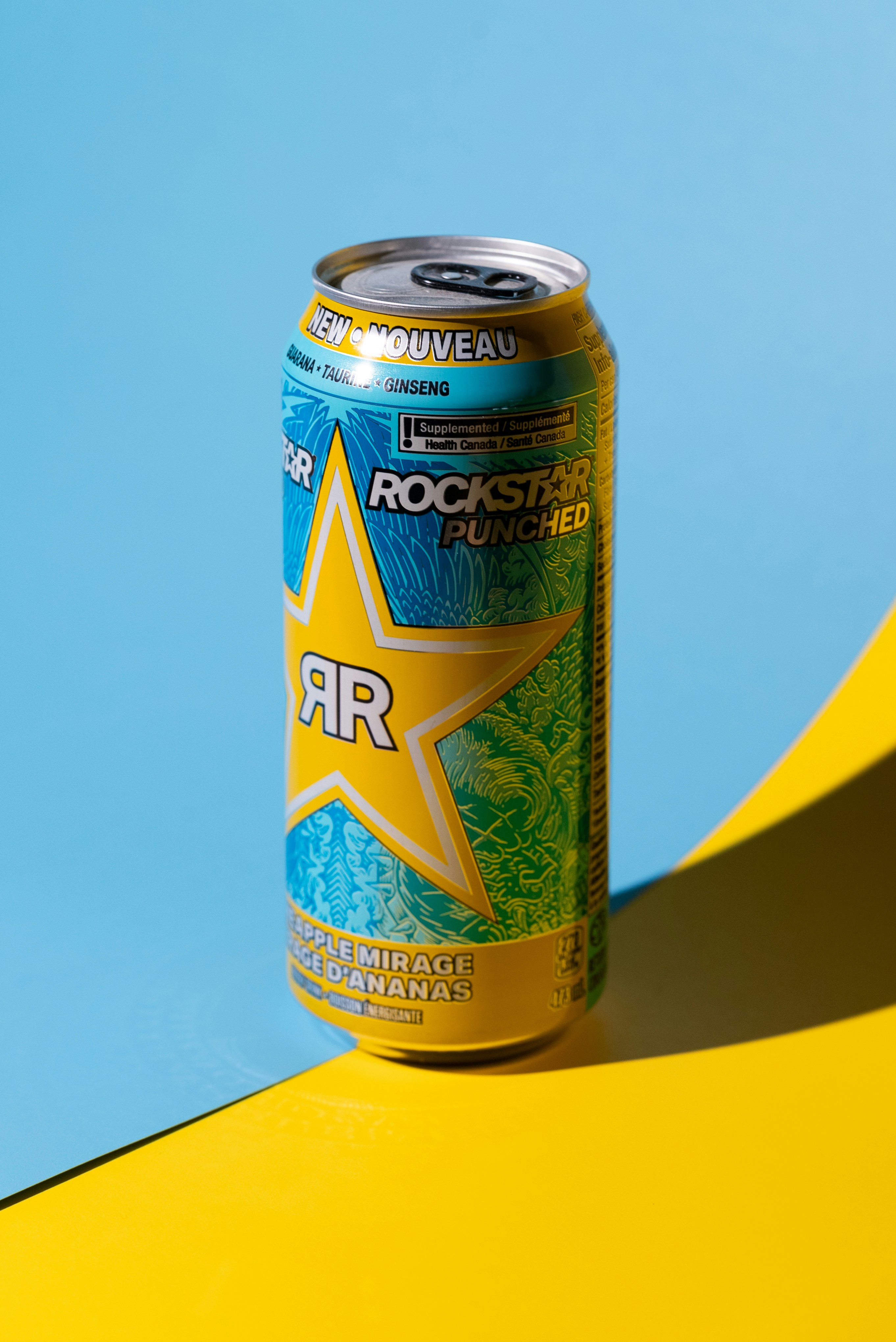 A can of rock star on a yellow and blue background photo – Free Drink ...