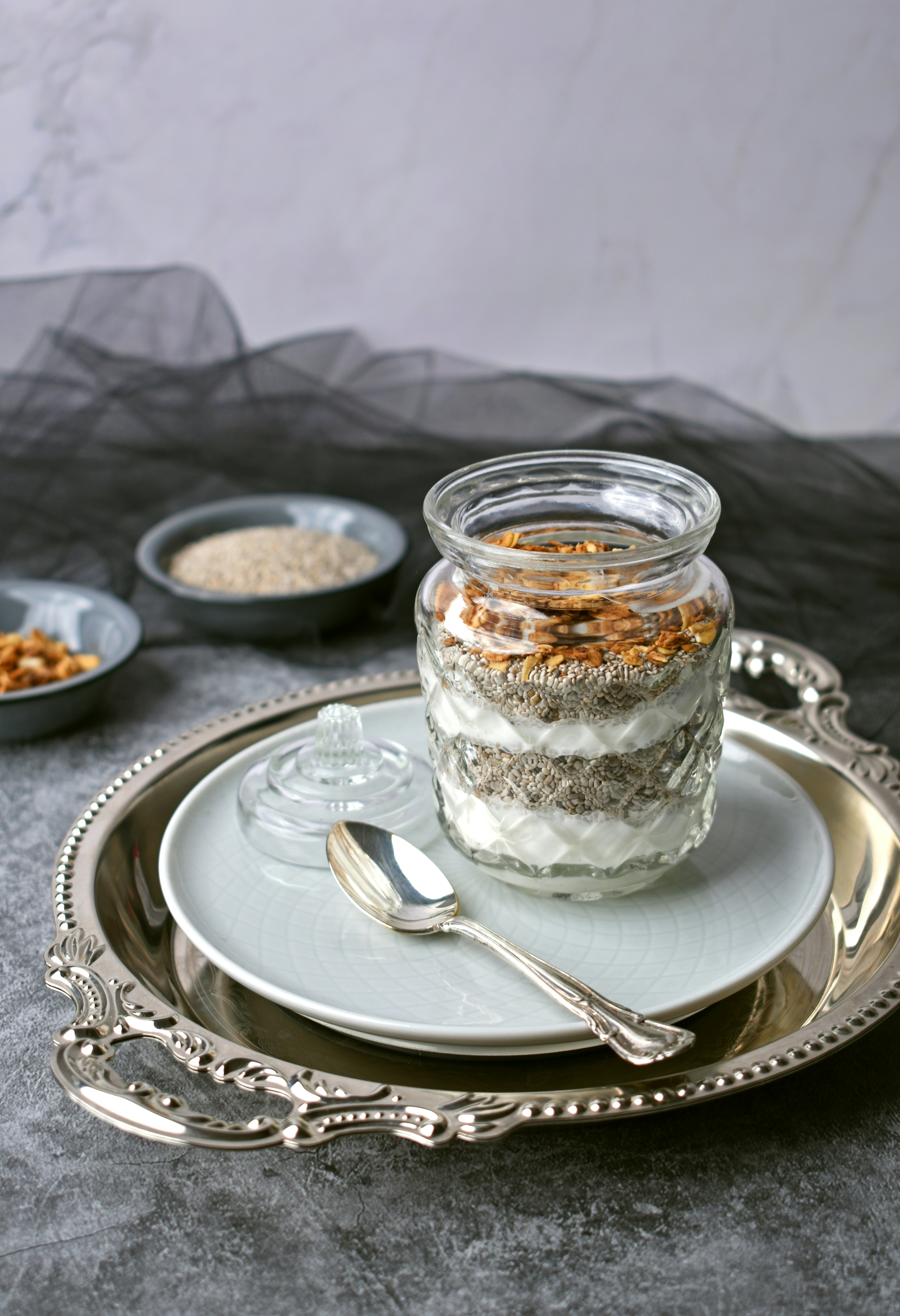 Layered Crunch: Granola Jar on an Ornate Silver Tray