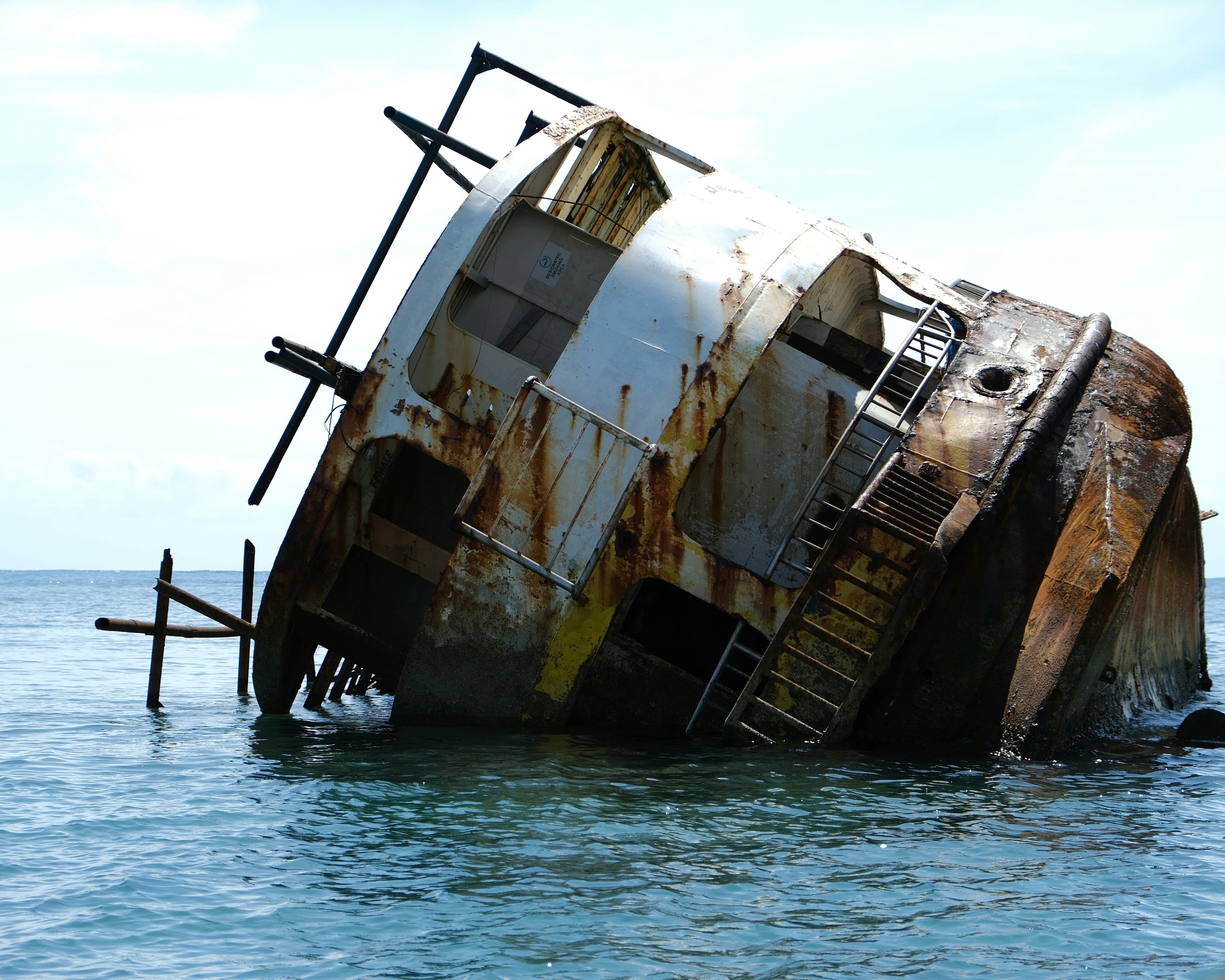 A rusted out ship in the middle of the ocean photo – Free Palawan Image ...