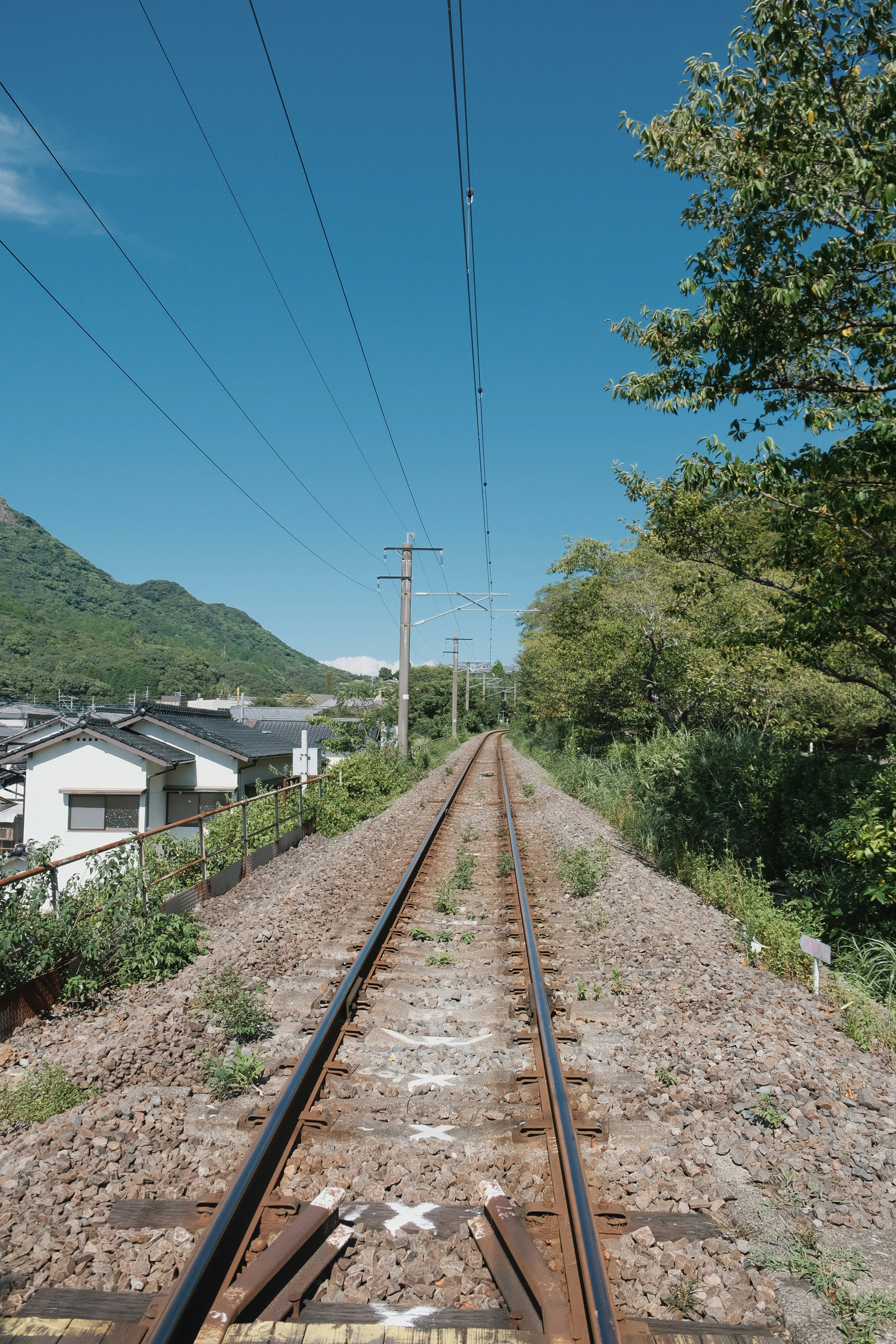 A train track running through a rural area photo – Free Road Image on ...