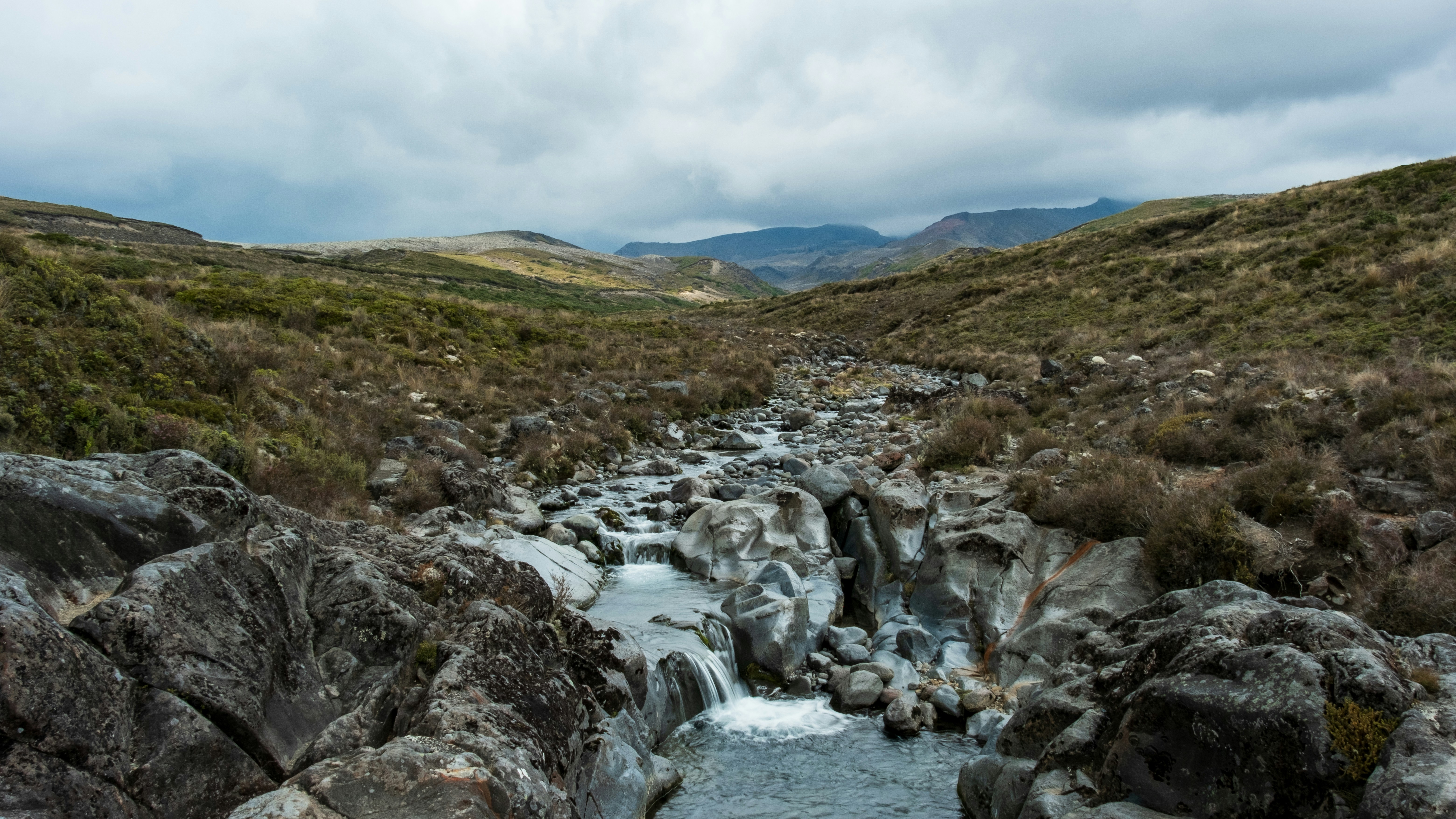 River meandering through rocky landscape under overcast skies.