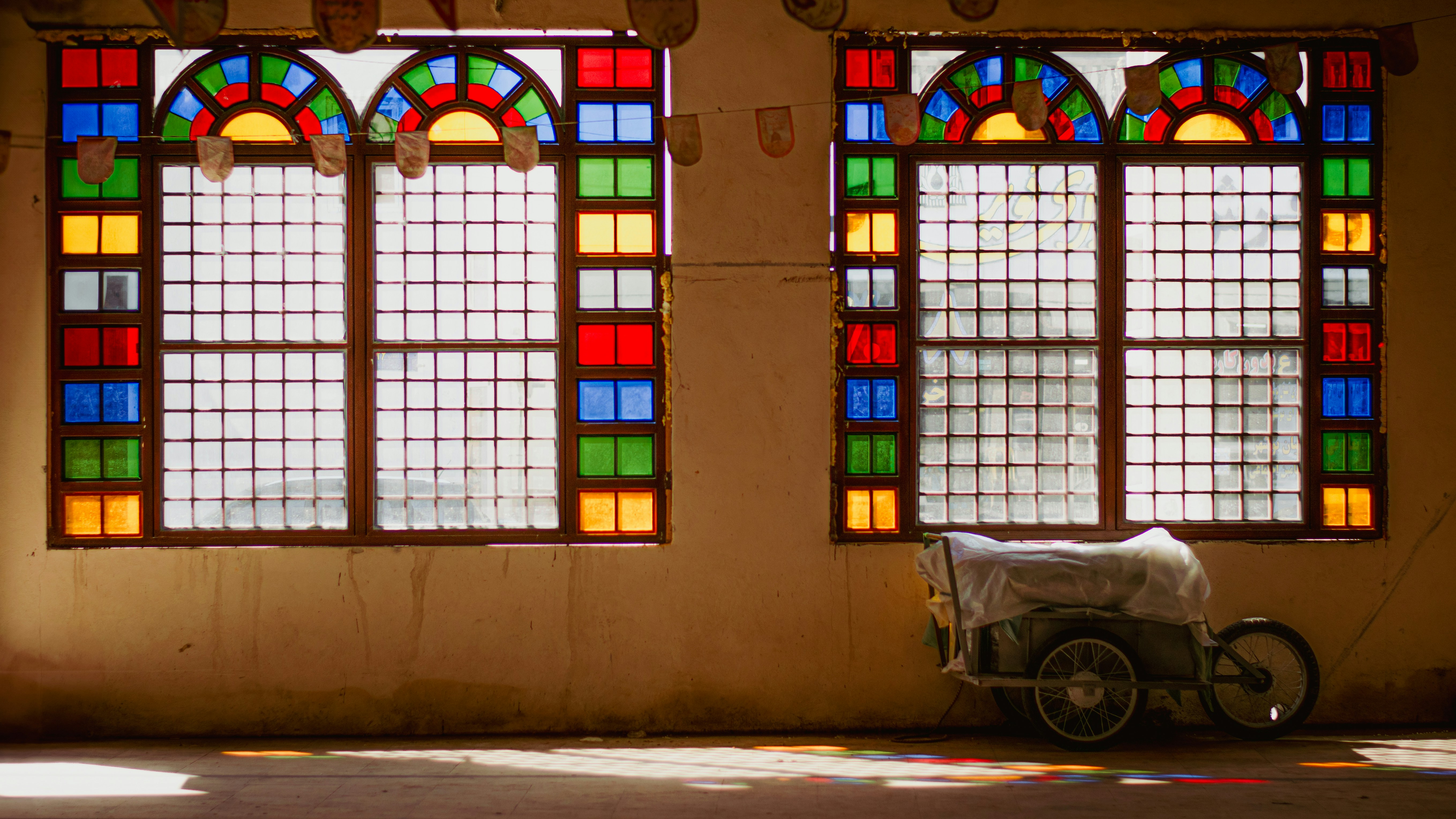 A bike parked in front of two stained glass windows photo – Free ...
