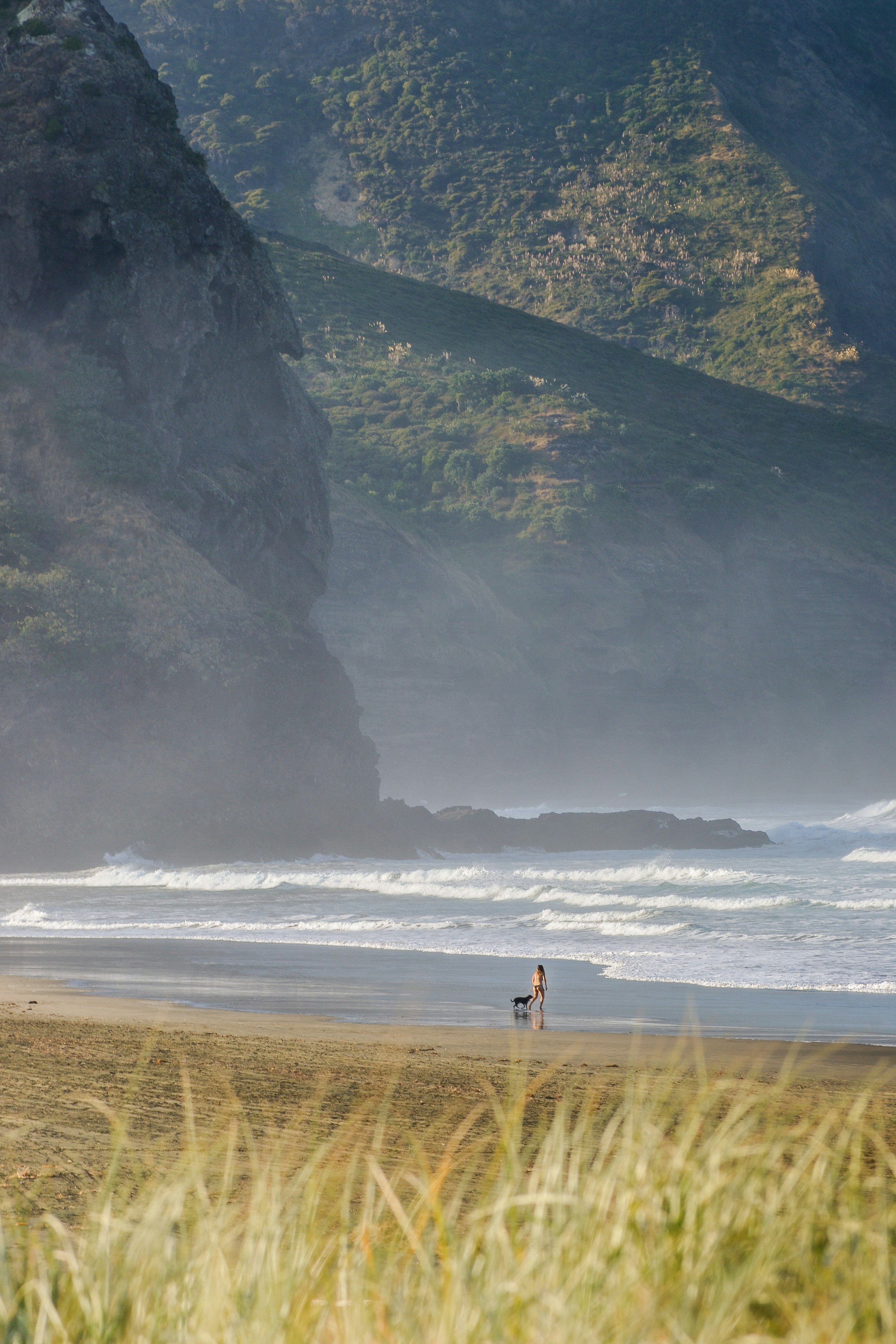 Mist, Cliff, and a Lone Beach Walker