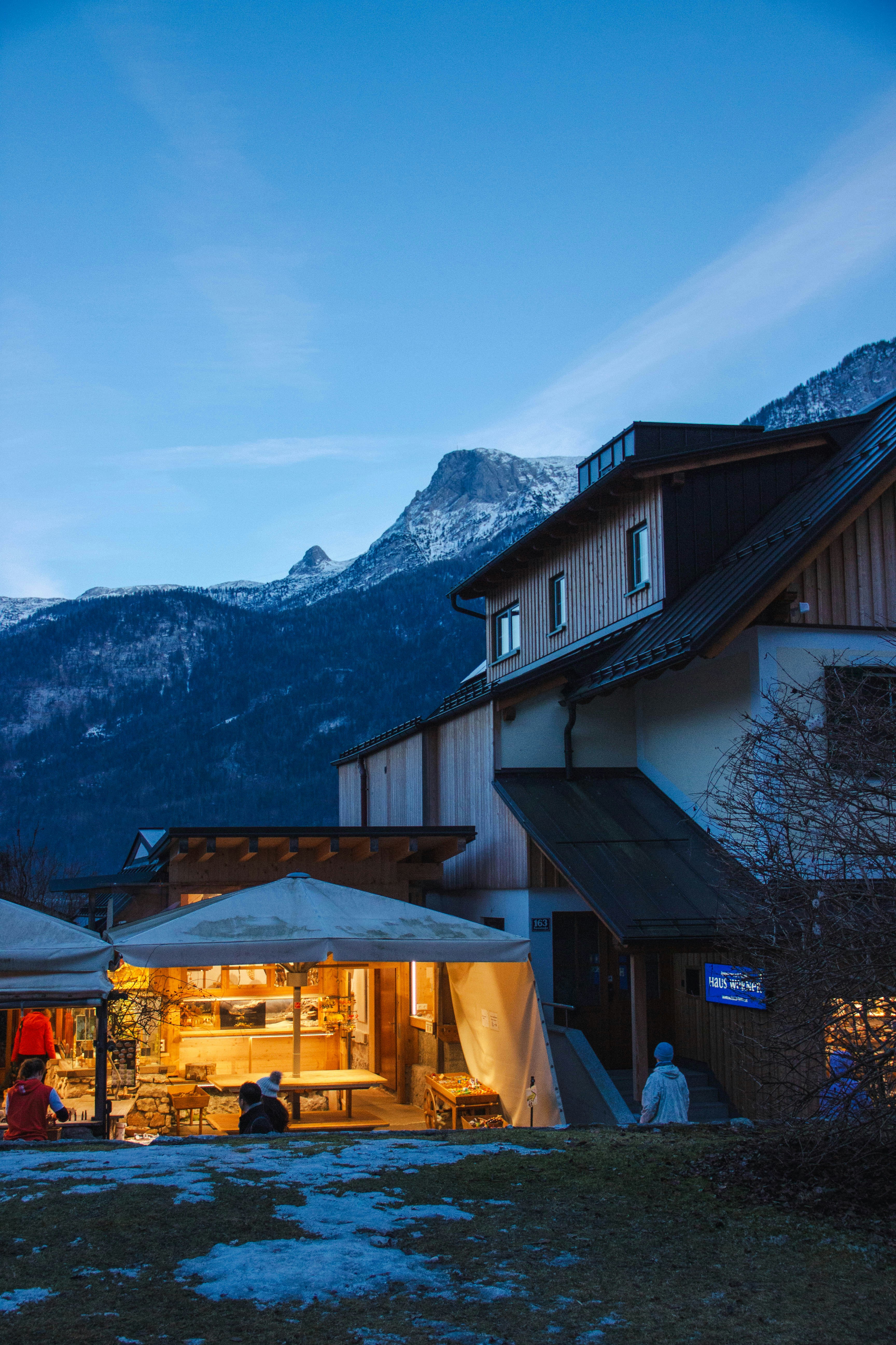 Alpine Lodge at Dusk: Warm Light Meets Snowy Silhouettes