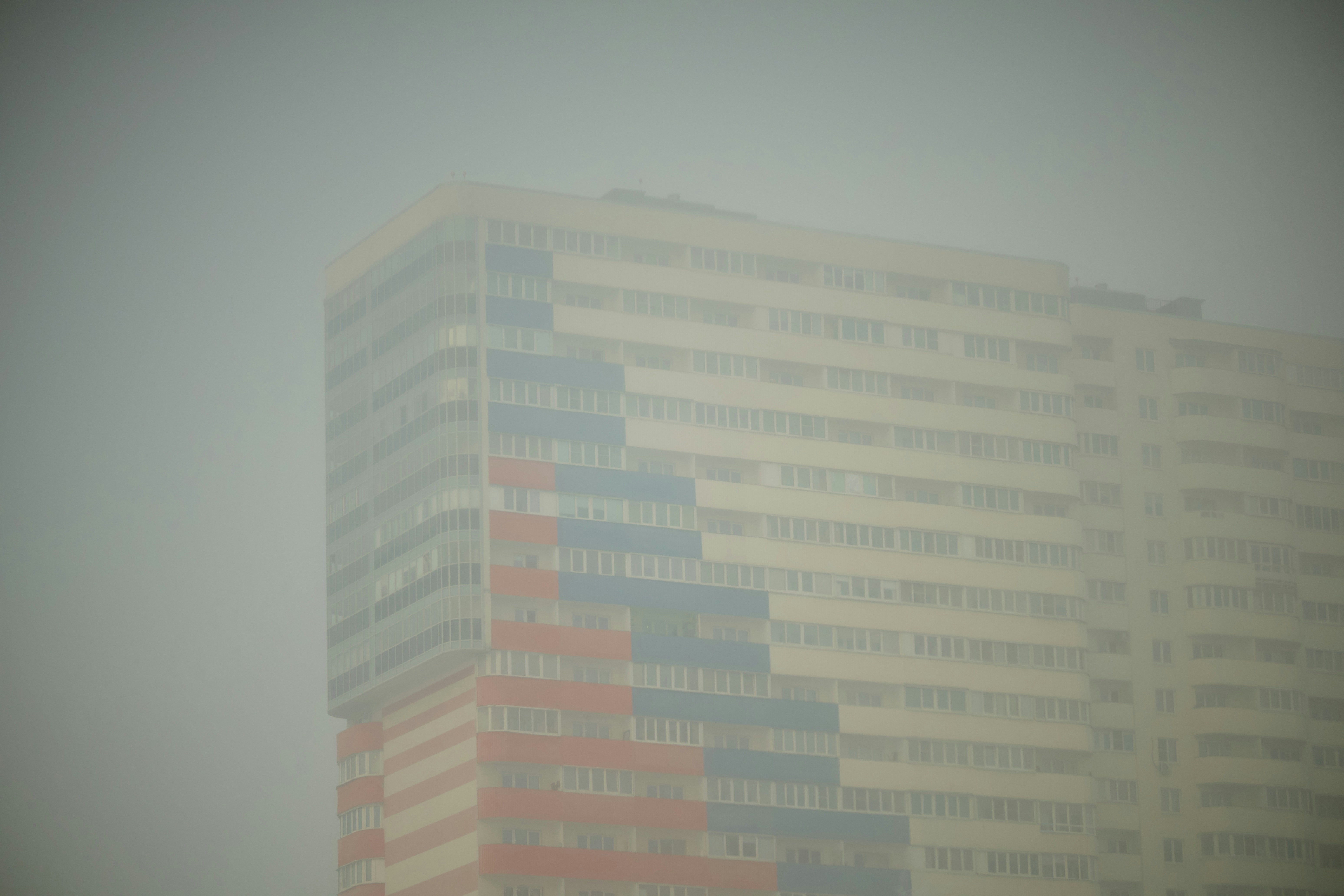 A tall building with a red white and blue flag on it