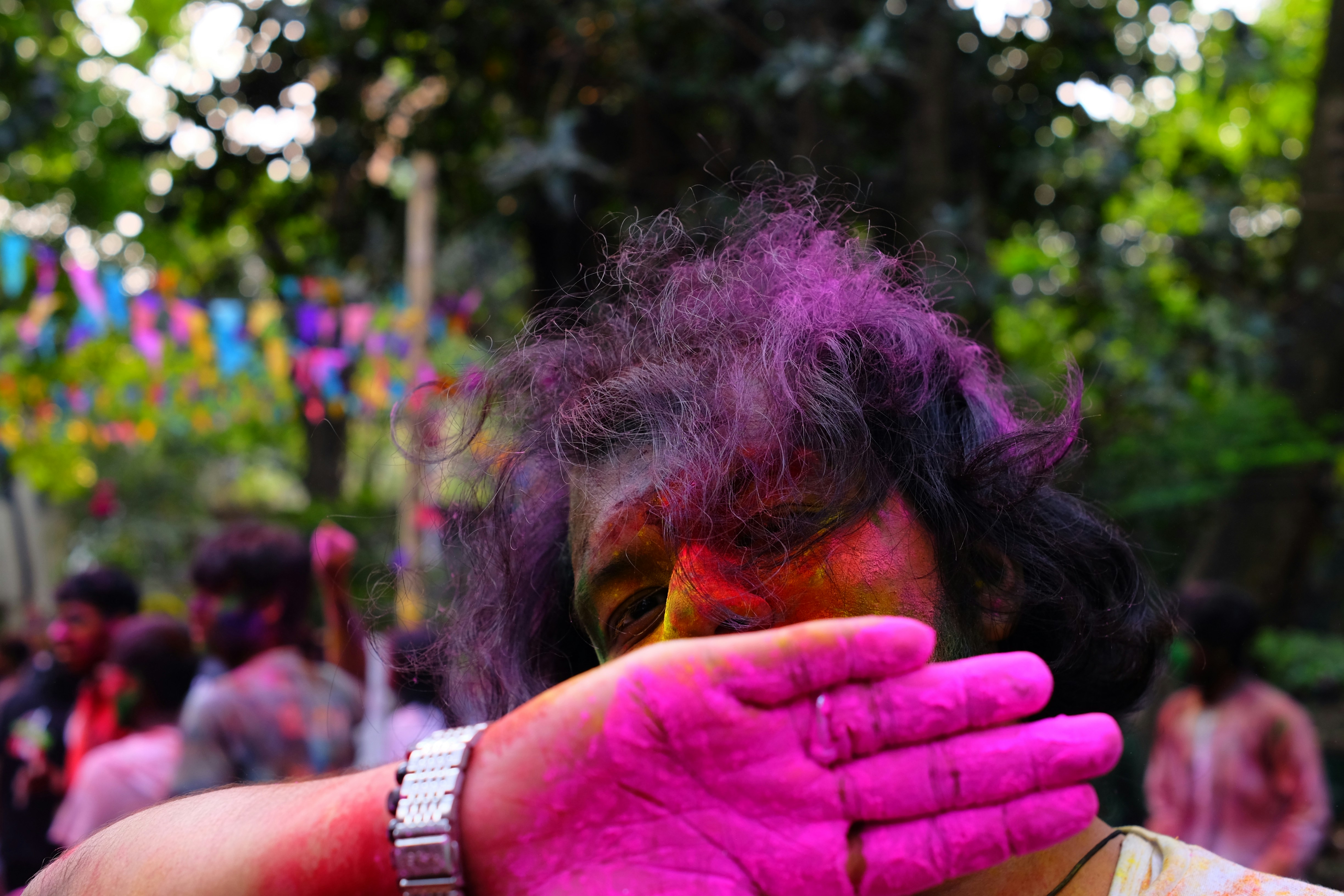Pigment in Motion: A Pink-Hand Portrait at a Holi Festival