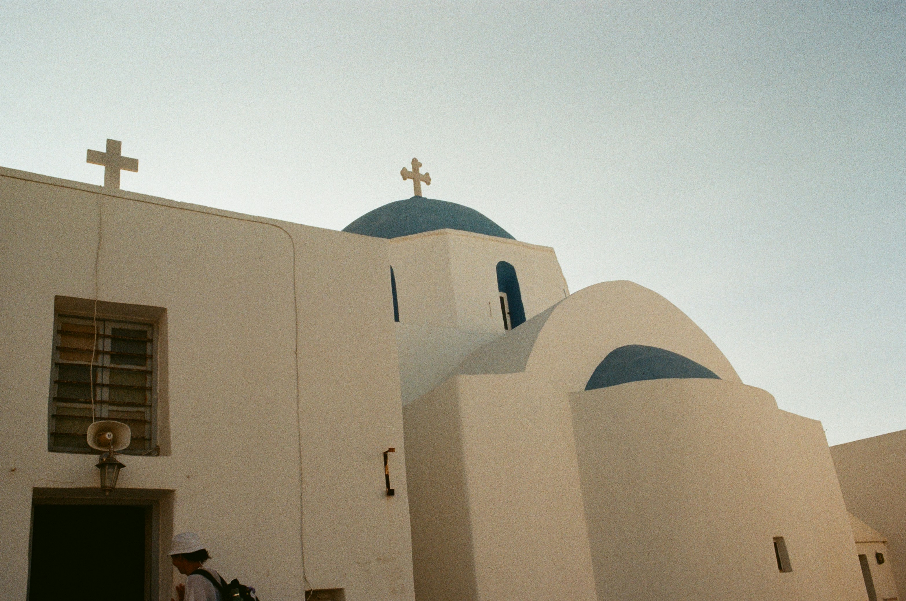 A white building with a cross on the top of it photo – Free Religious ...