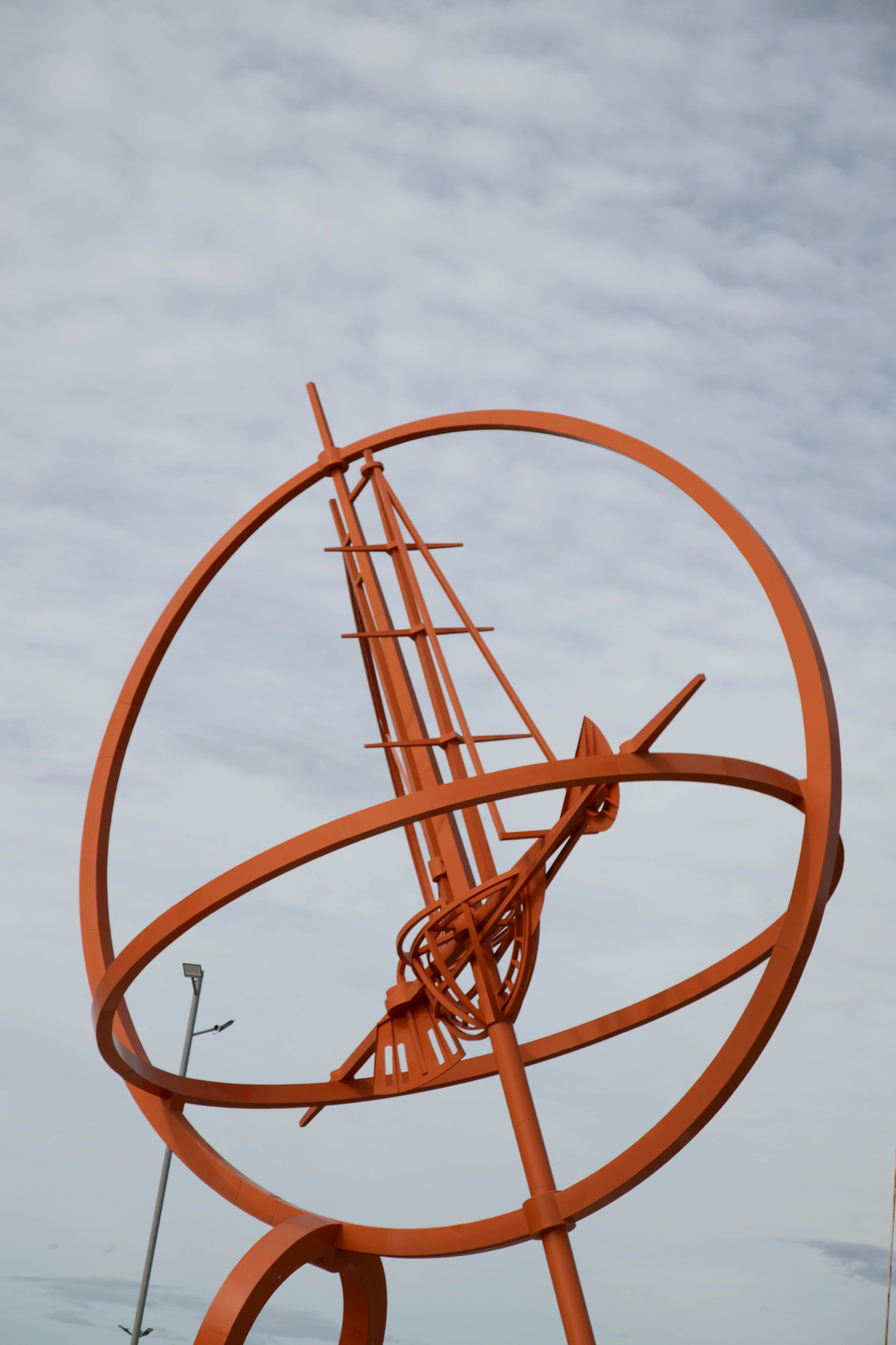 Orbital Ring Sculpture Against a Calm Sky