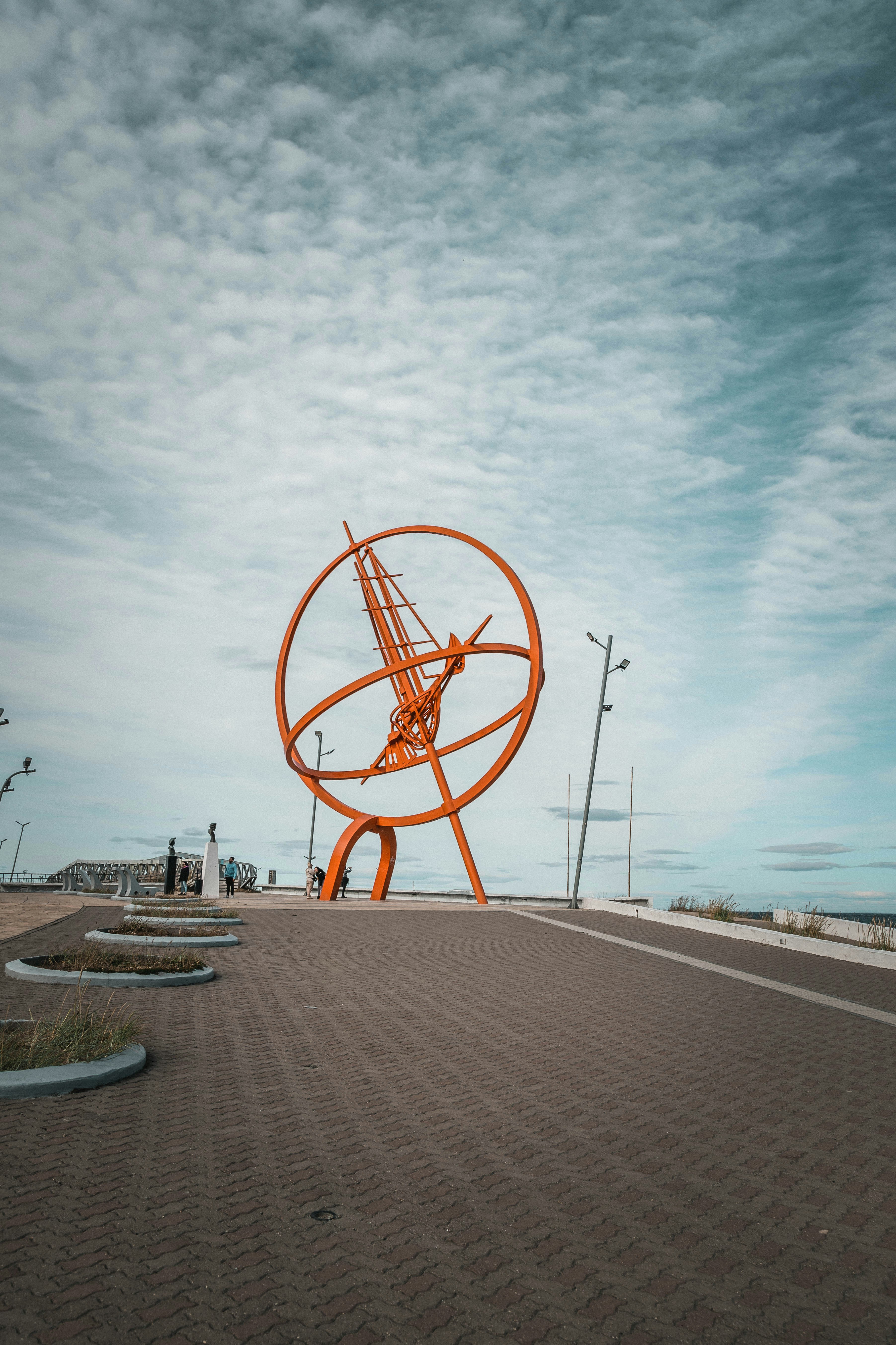 Circular Orbit: An Orange Sculptural Arc by the Seaside Boardwalk