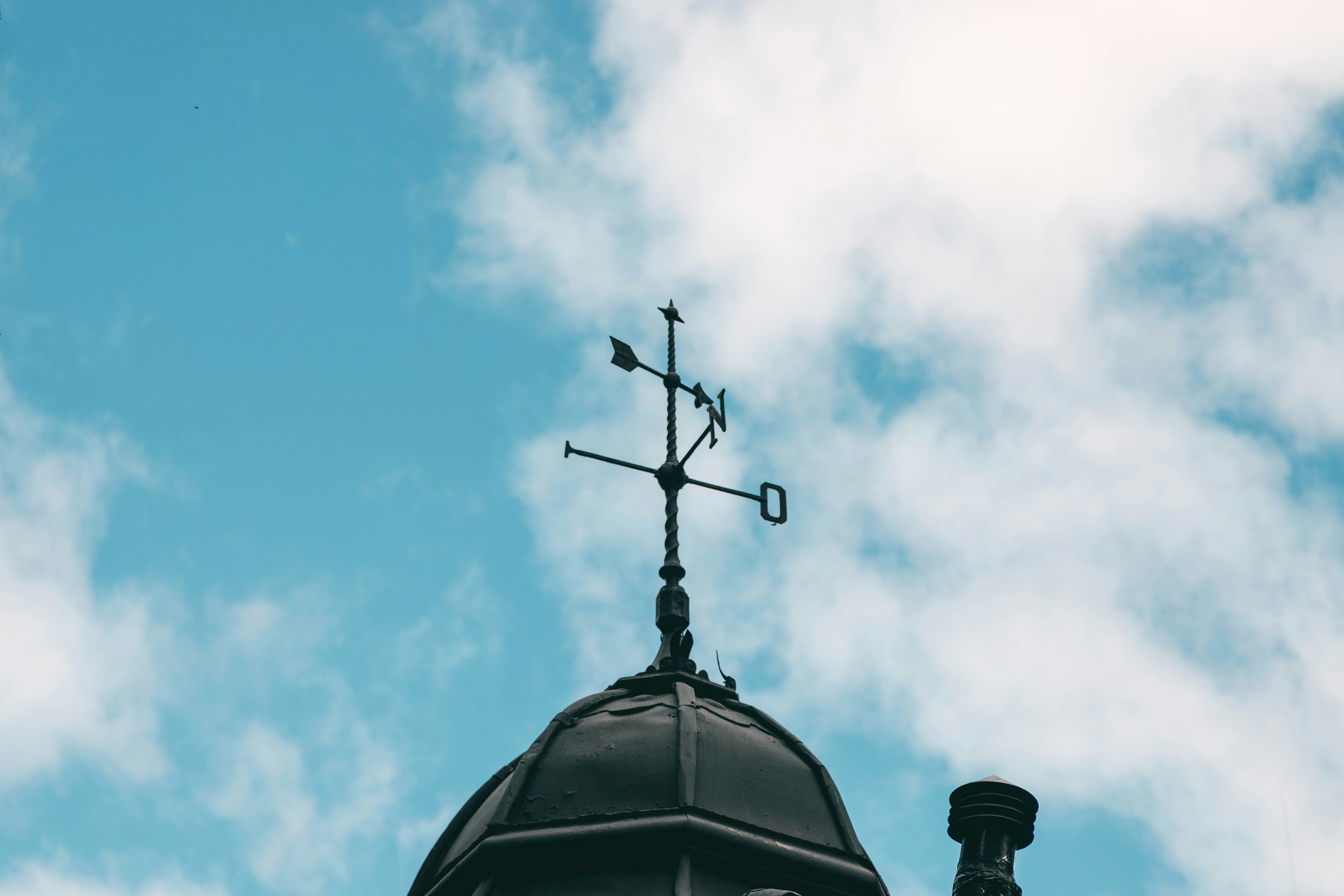 A clock tower with a weather vane on top of it photo – Free Latin ...