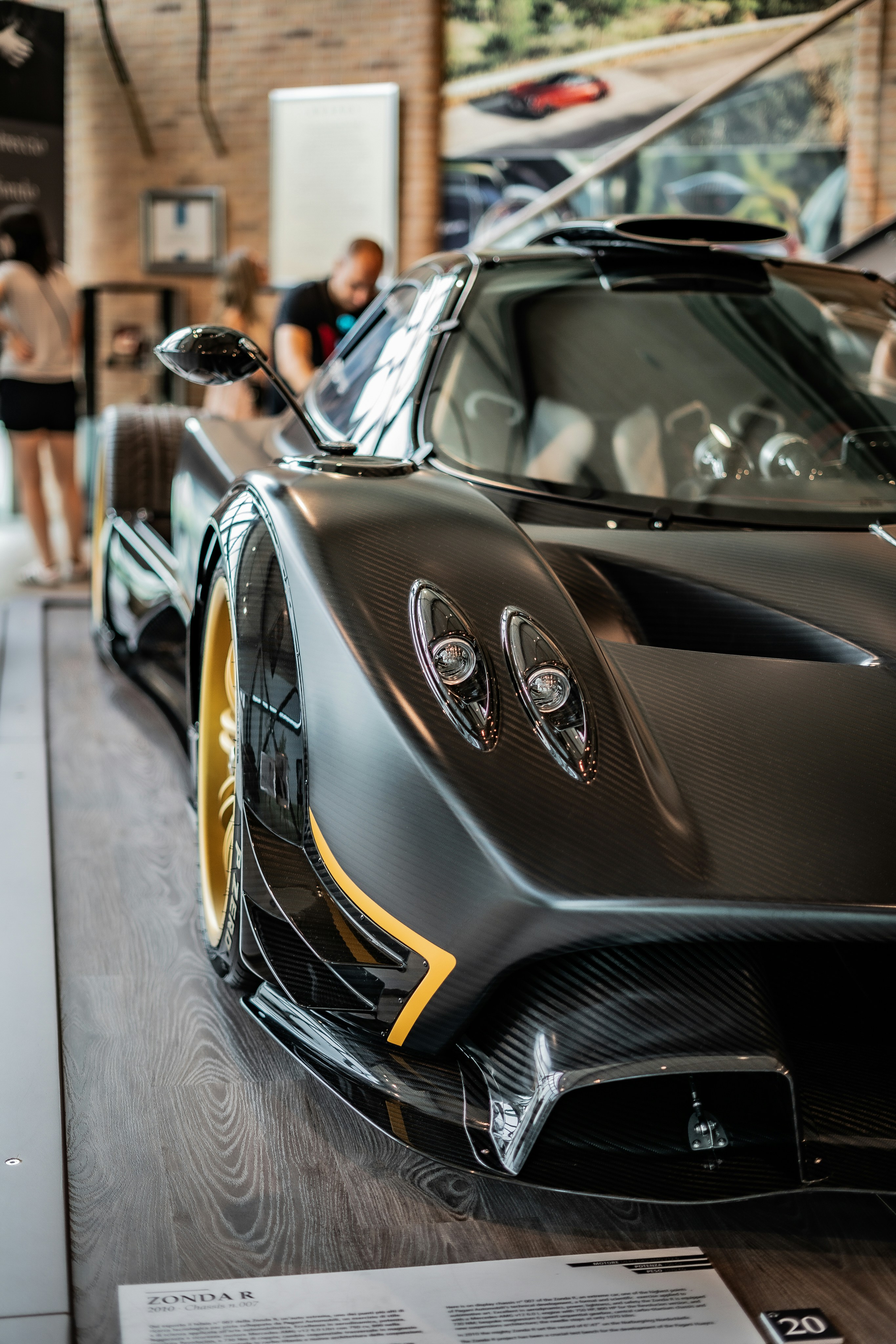 A black sports car on display at a car show photo – Free Supercar Image ...