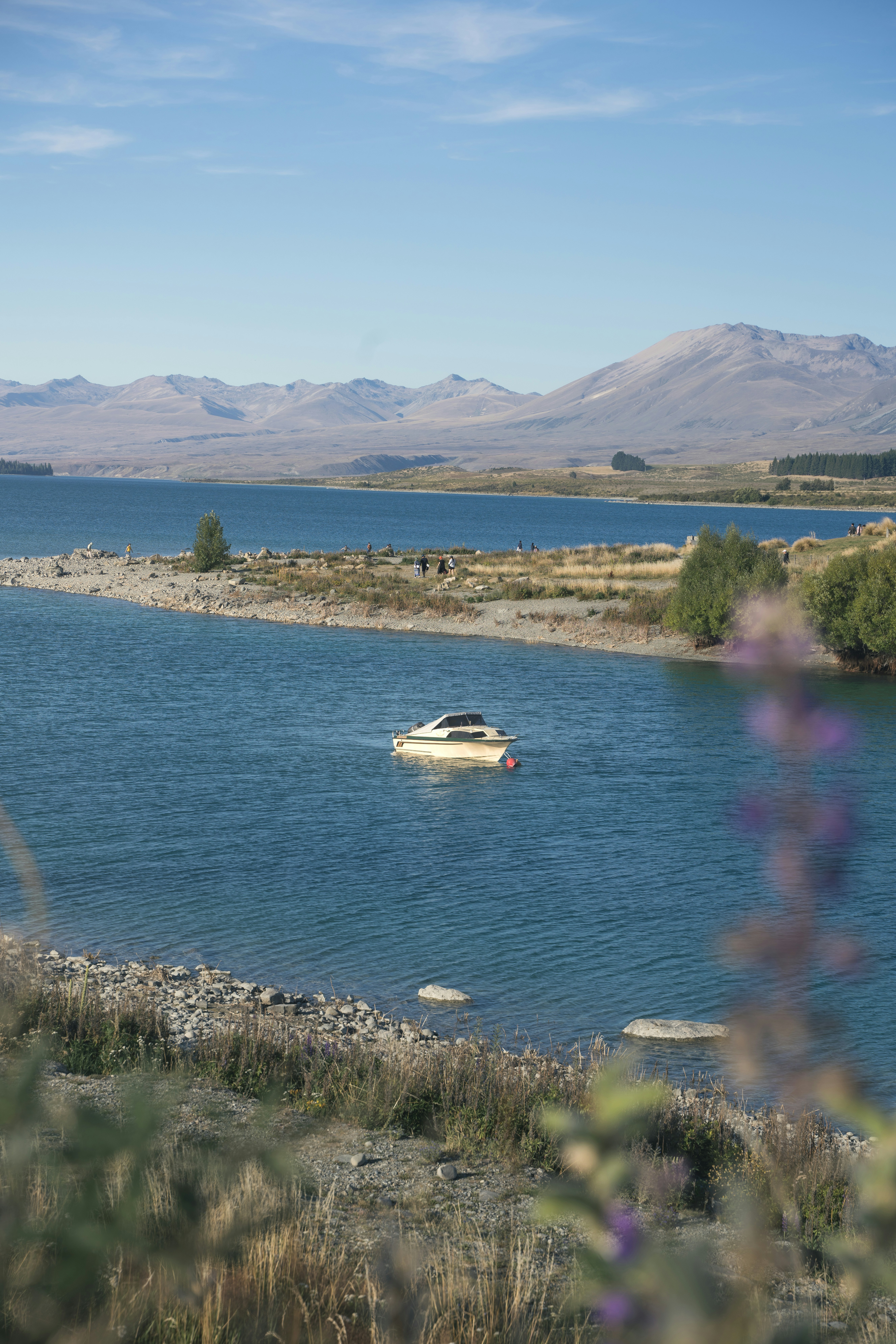 Silent Vessel on Aegean-like Lake Under Expansive Sky