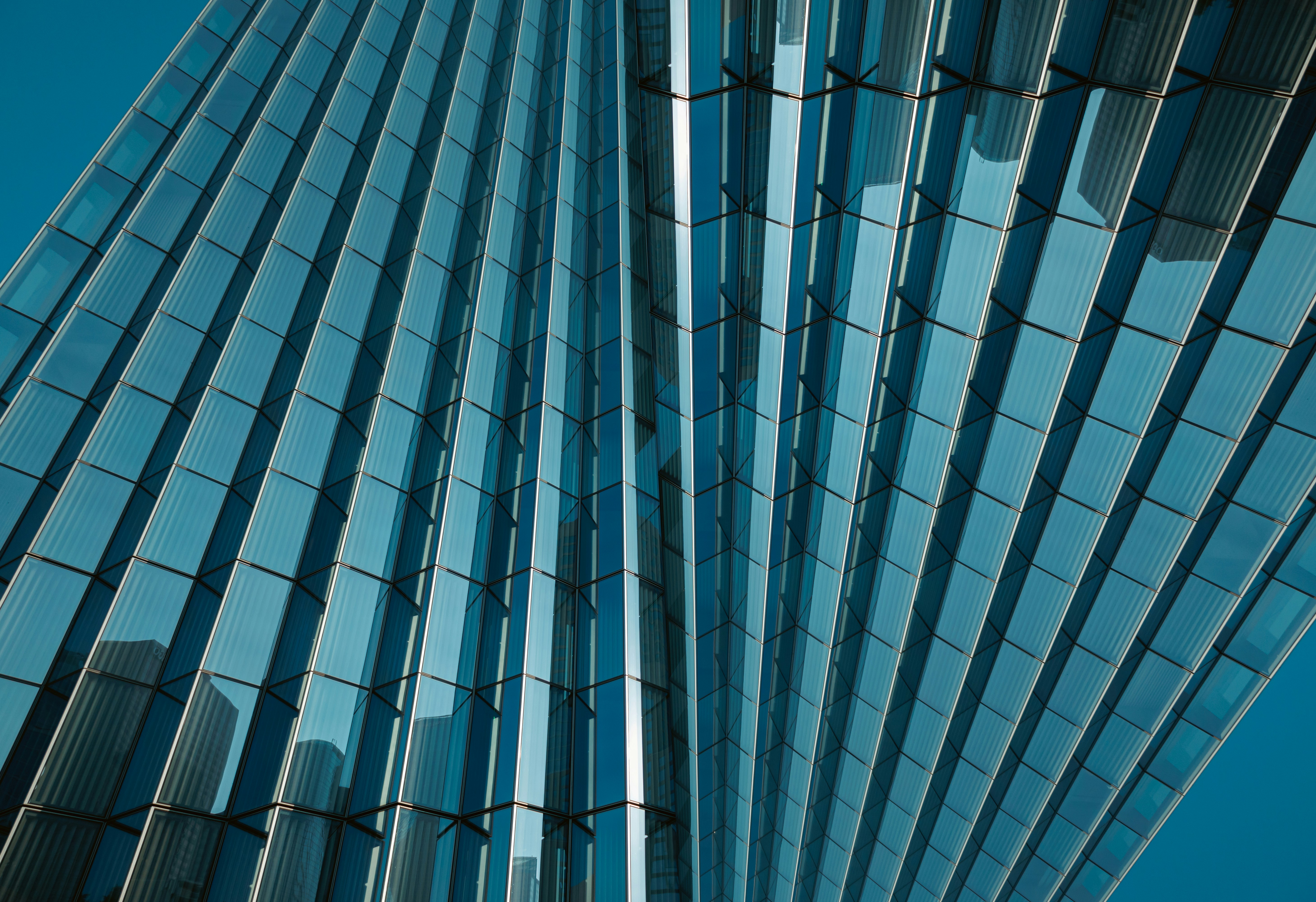A close up of a tall building with many windows photo – Free Abstract ...