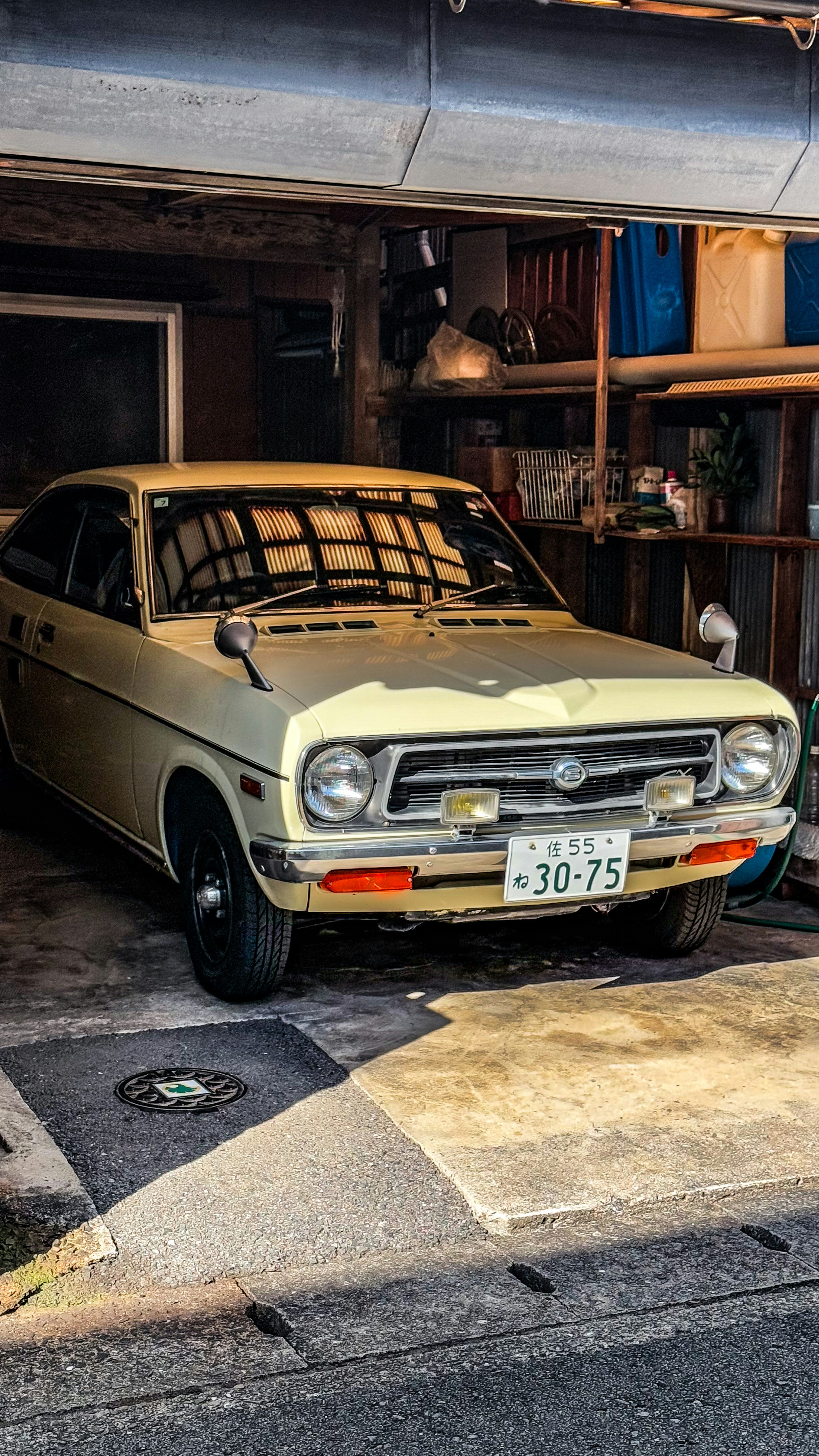 A car parked in a garage next to a fire hydrant