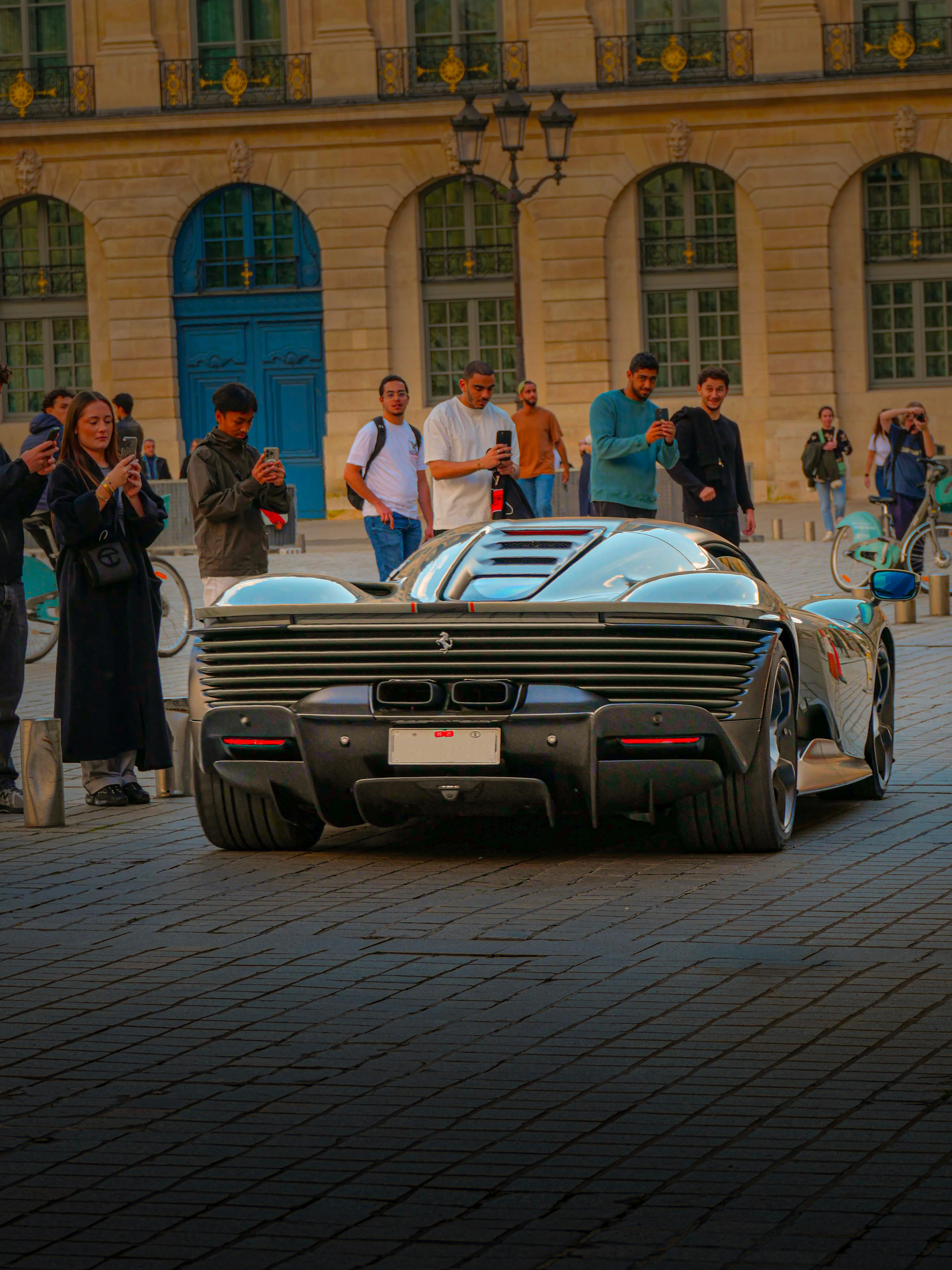 A car parked in front of a crowd of people photo – Free Car Image on ...