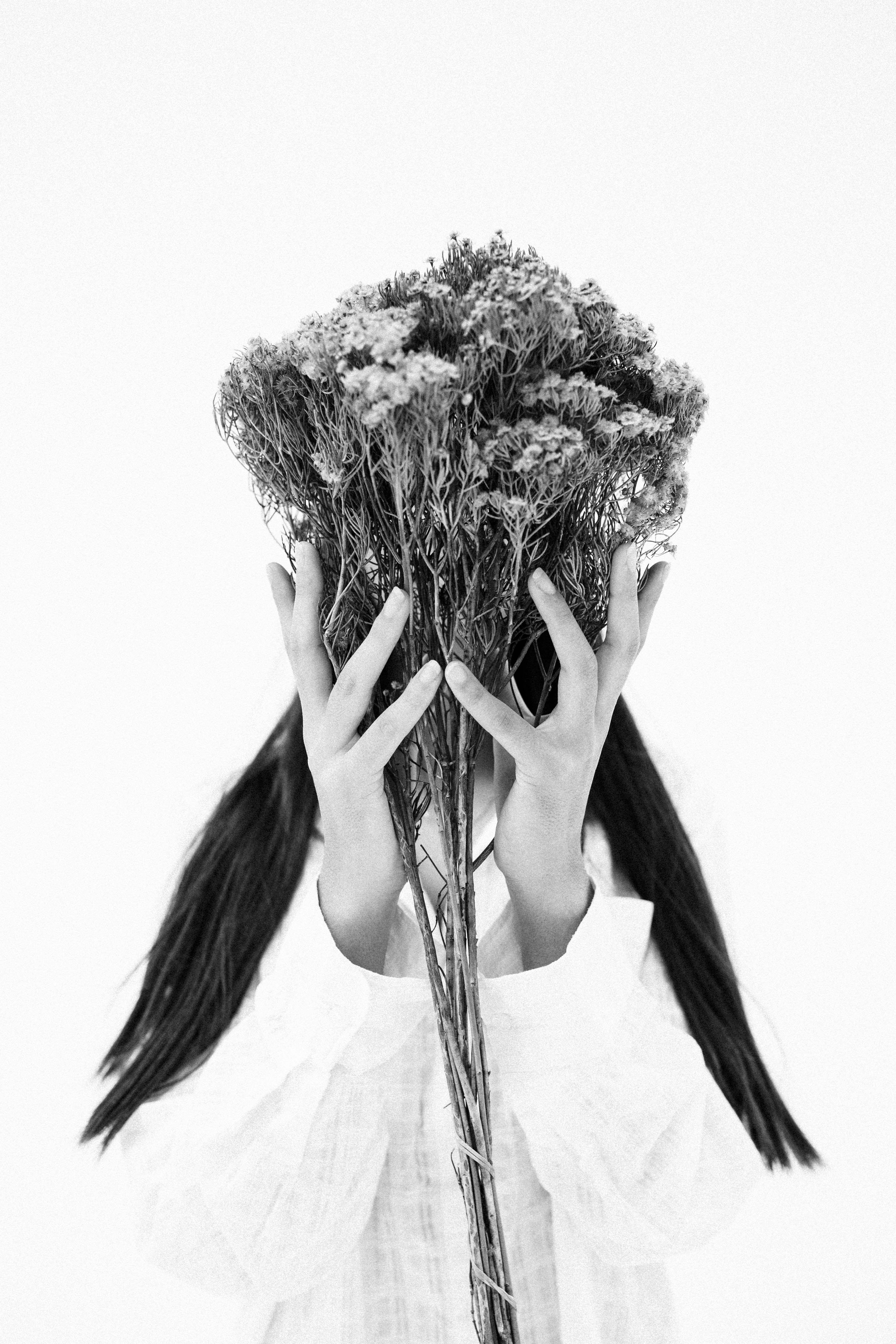 A woman covering her face with a bunch of flowers photo – Free Flower ...