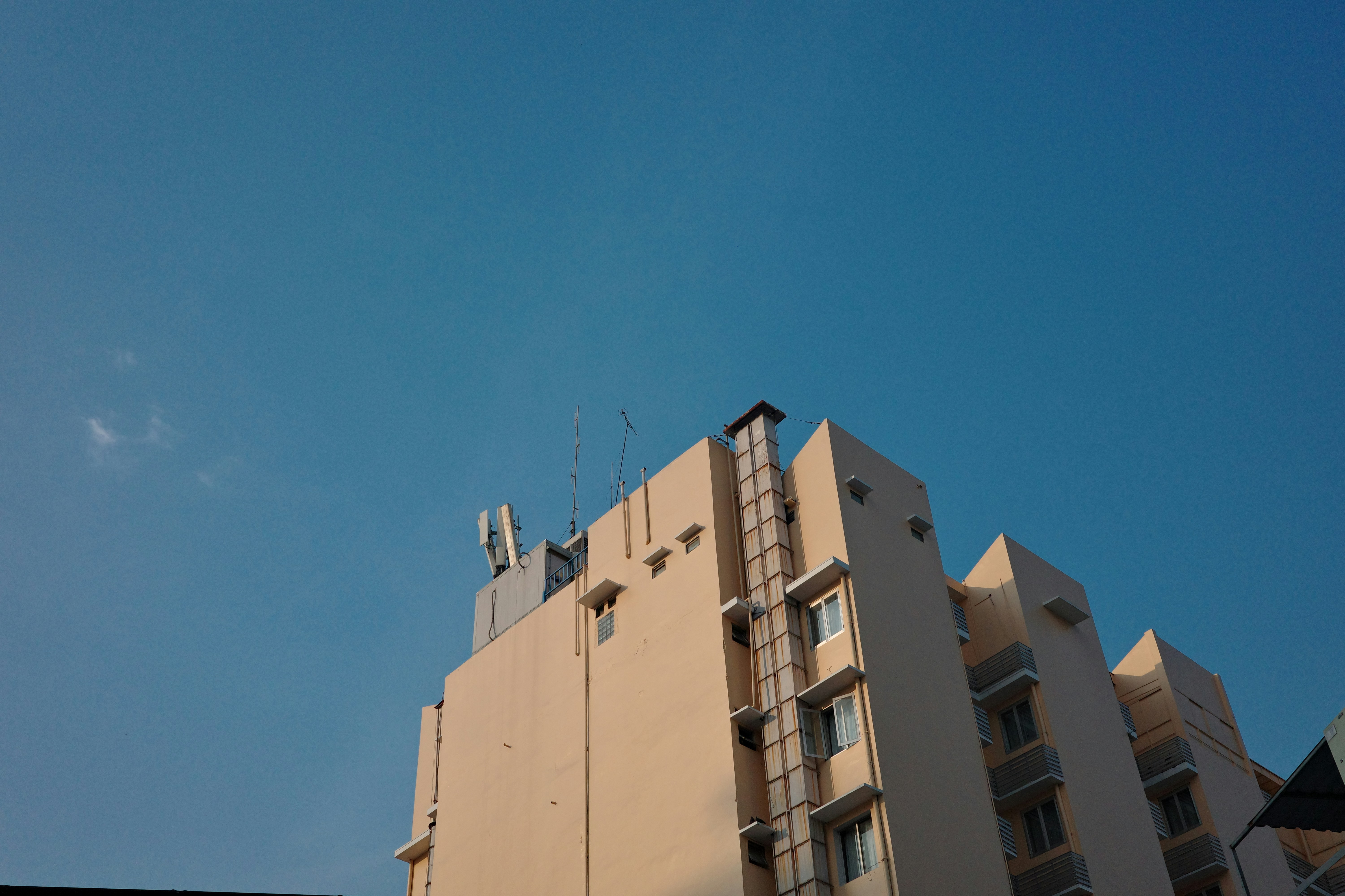 A tall white building sitting next to a tall white building photo ...