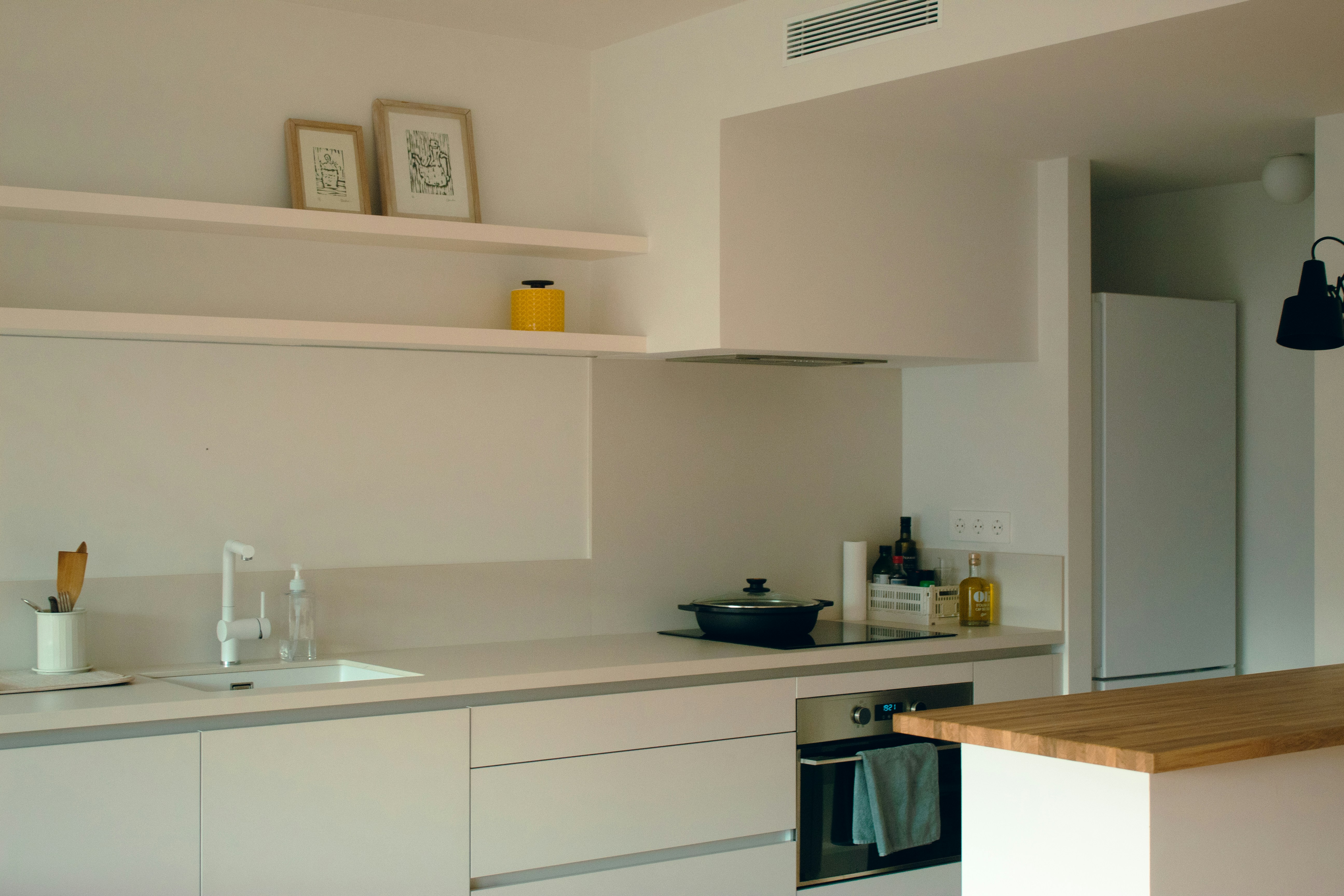 A white kitchen with a wooden counter top photo – Free Indoors Image on ...