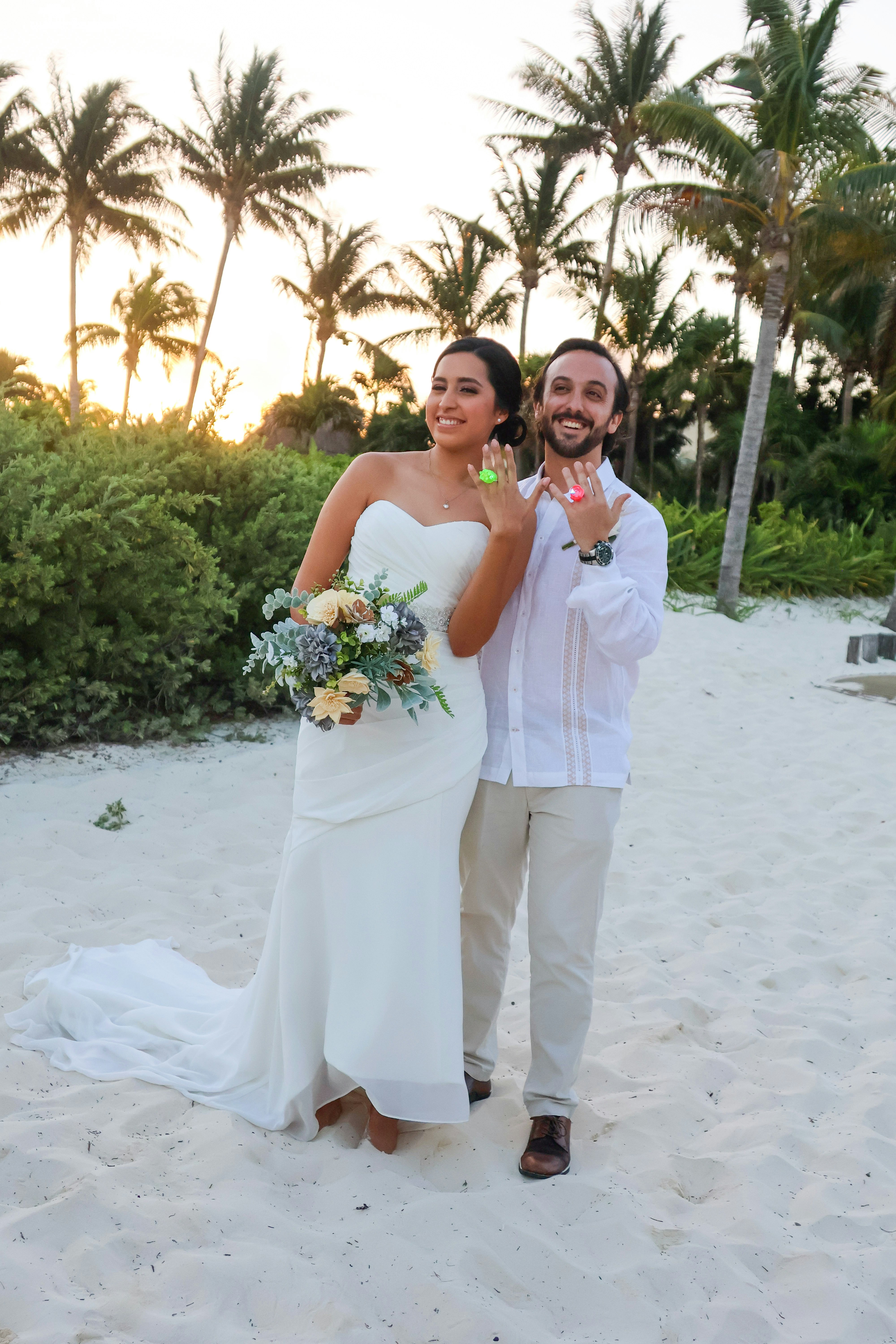 A bride and groom pose for a picture on the beach photo – Free Beach ...