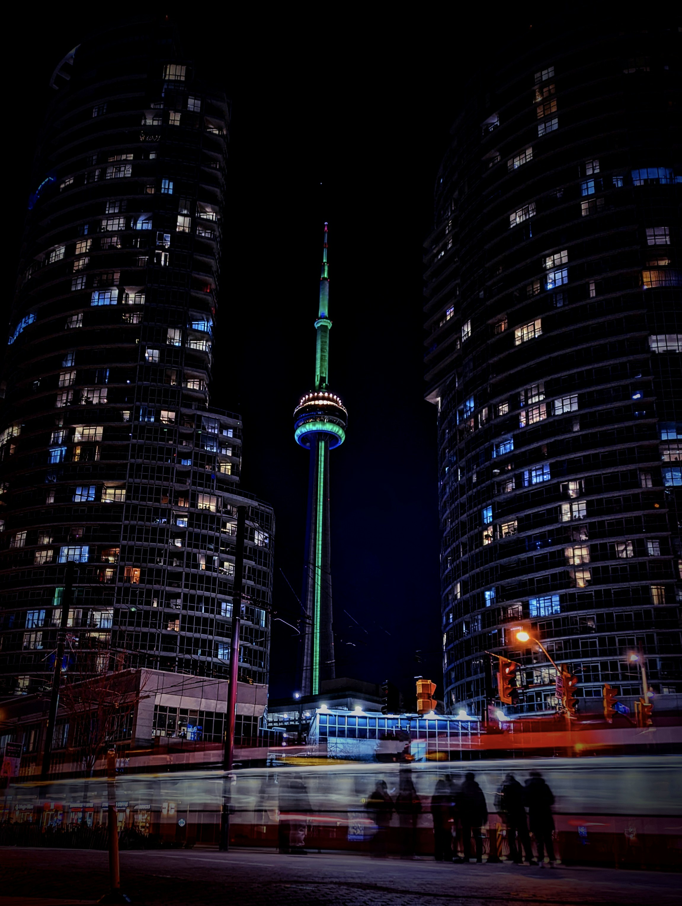 Neon Needle Between Glass Giants: CN Tower at Night