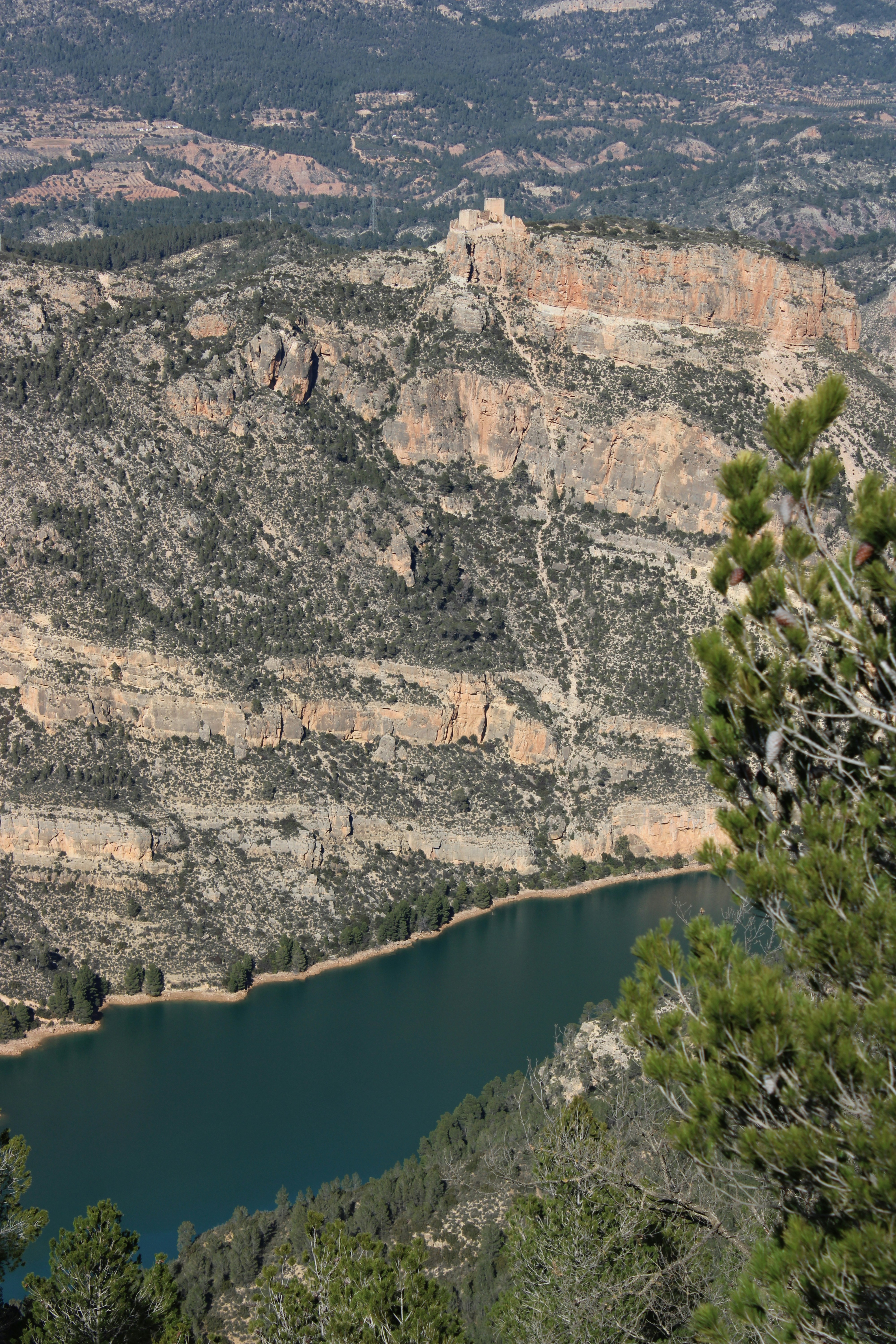 Cliffside Cathedral Over a Teal Reservoir