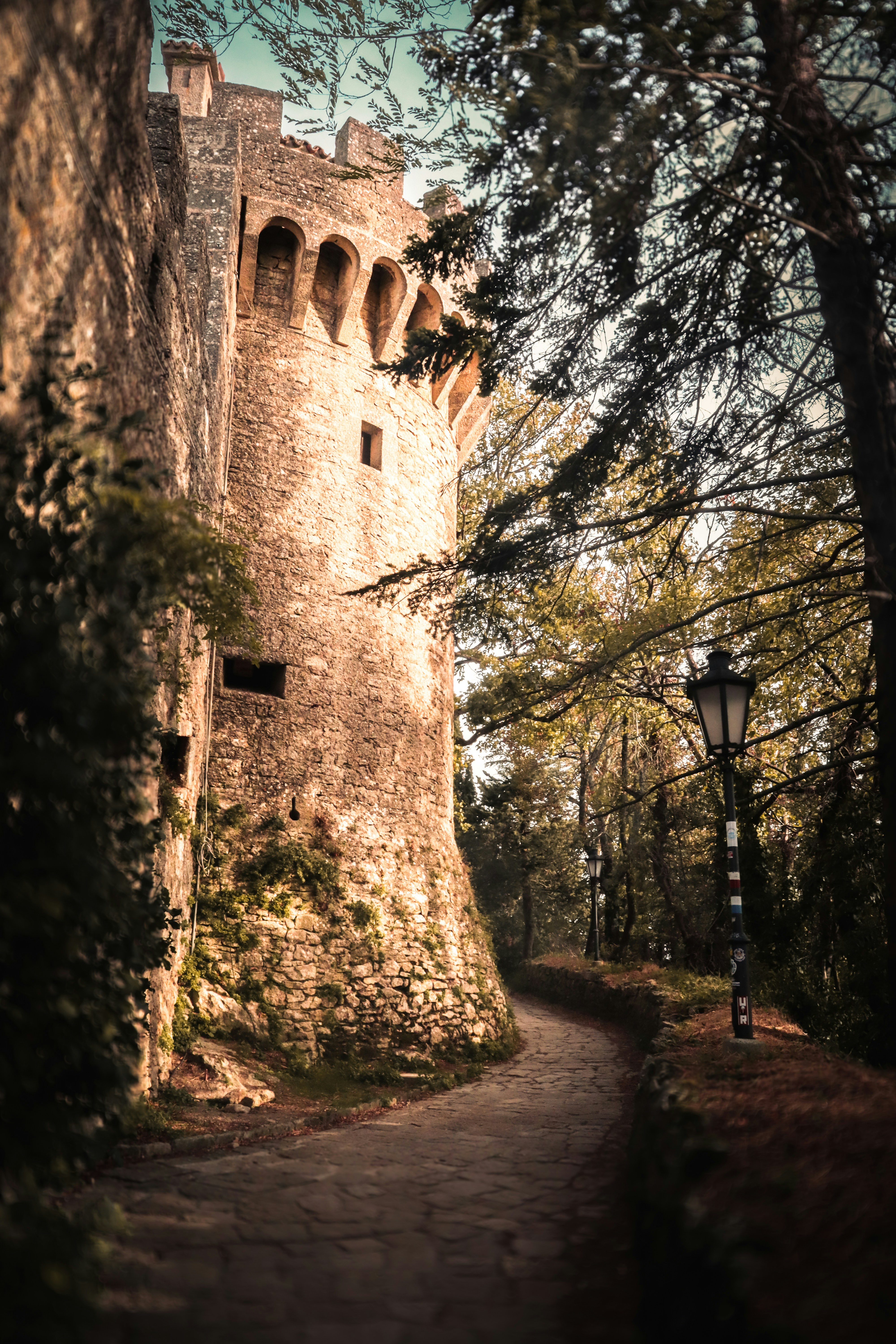 Autumn Light on a Castle Turret Beside a Cobblestone Path