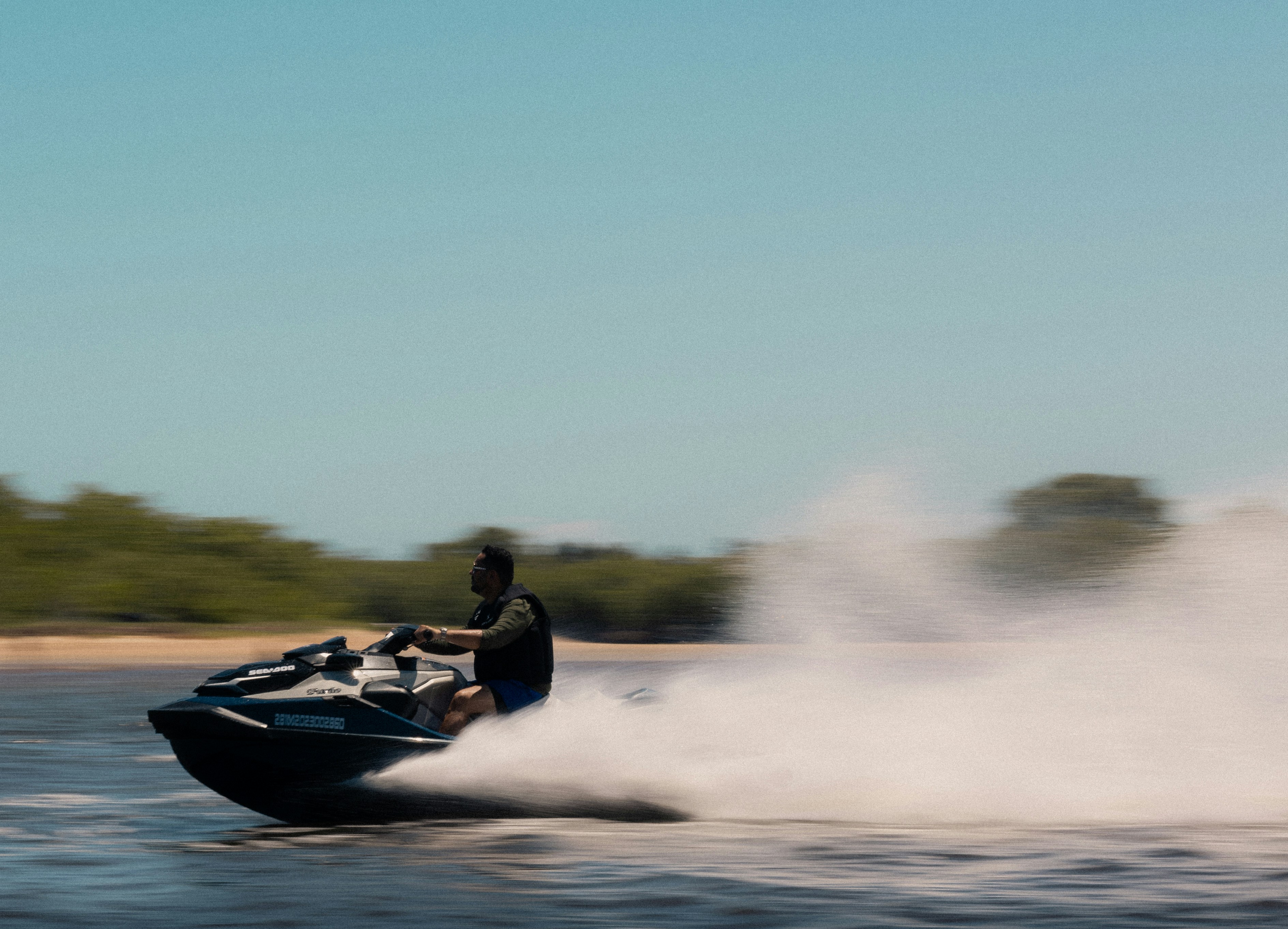 Arc of Spray: Jet-Ski Sprint Across a Sunlit Lake
