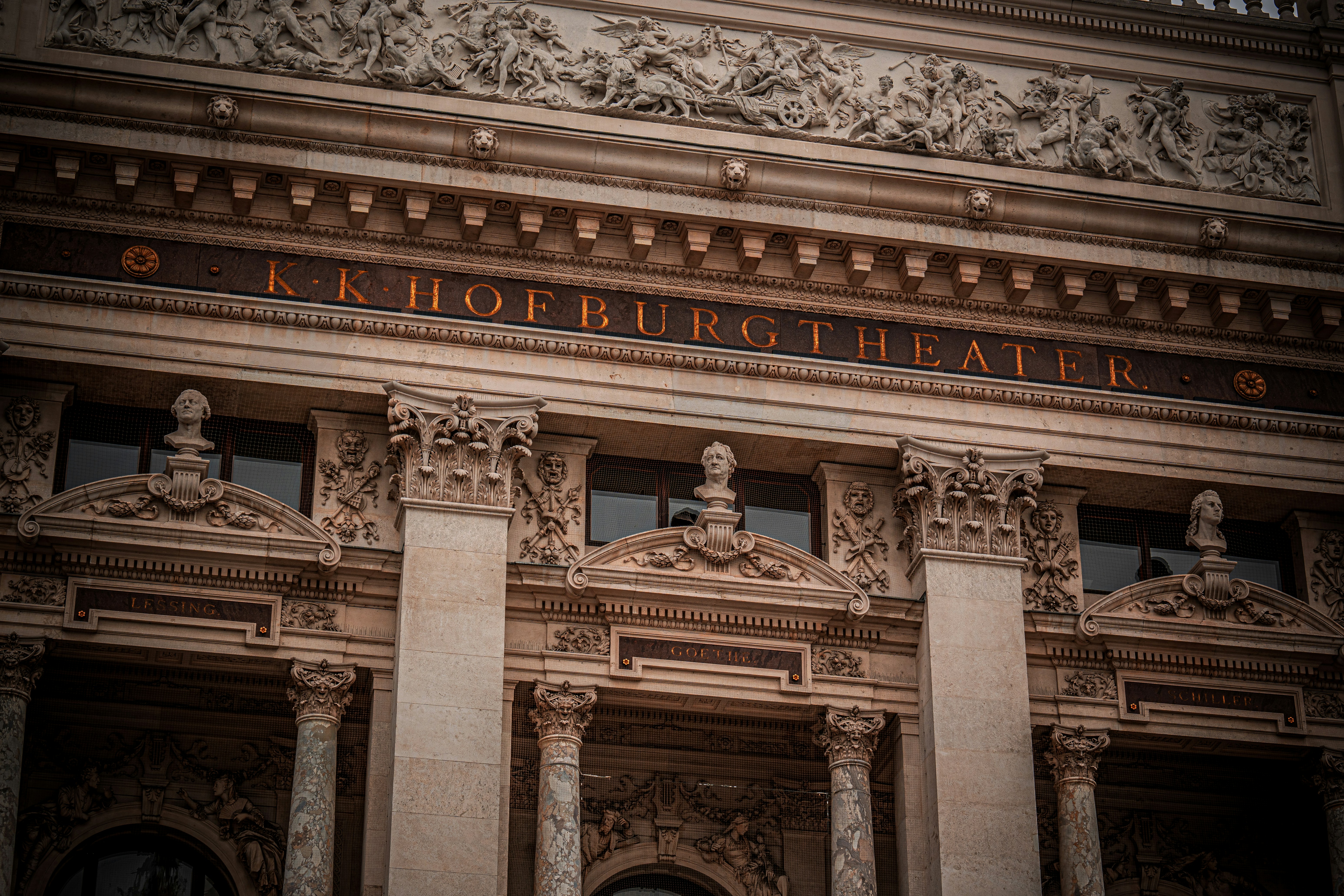 Ornate Theatre Facade: Carved Stone Grandeur Above the Entrance
