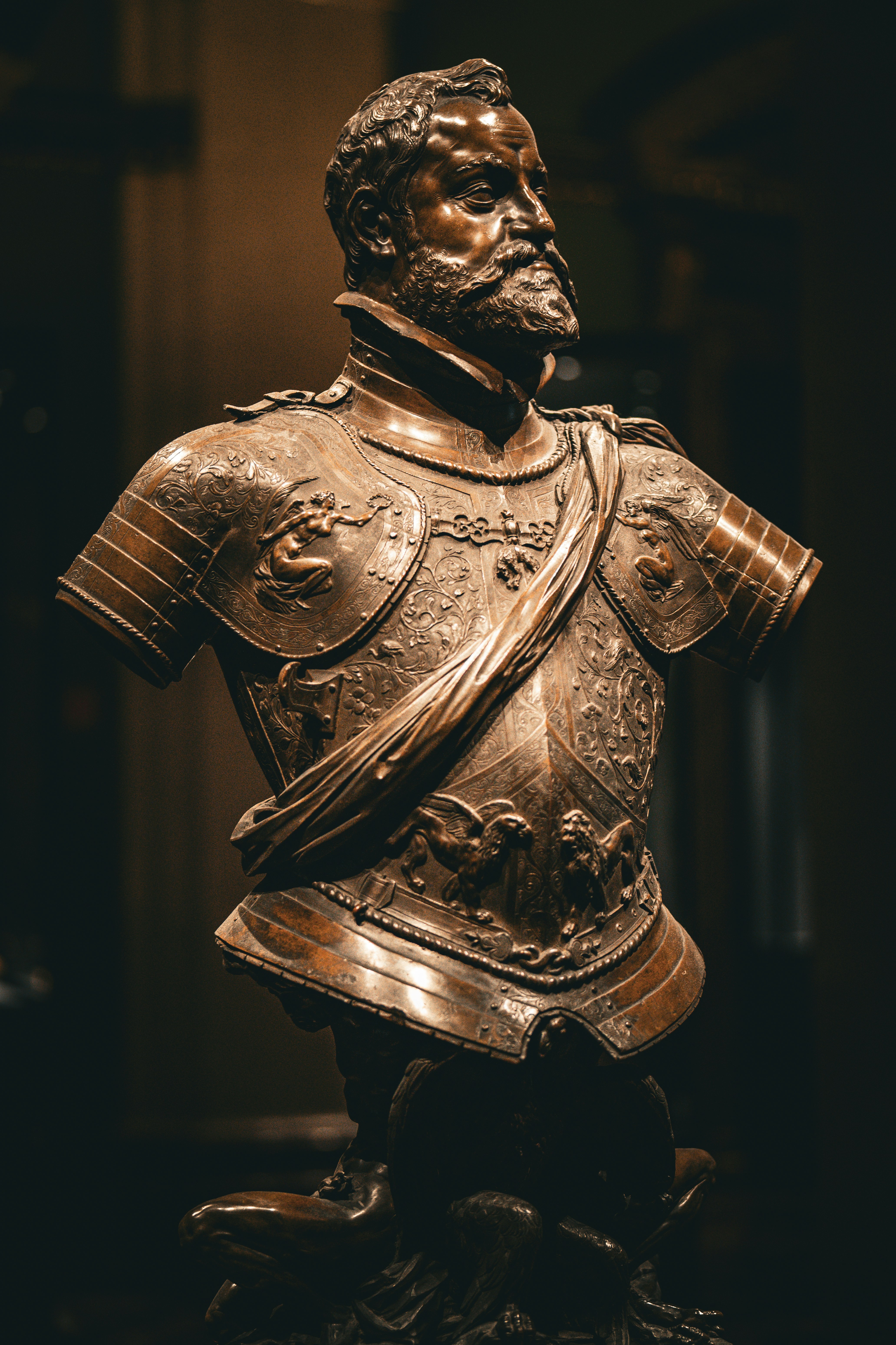 Bronze bust of a historical figure clad in ornate armor, showcasing intricate details and a majestic presence. The sculpture stands as a testament to artistry and valor.