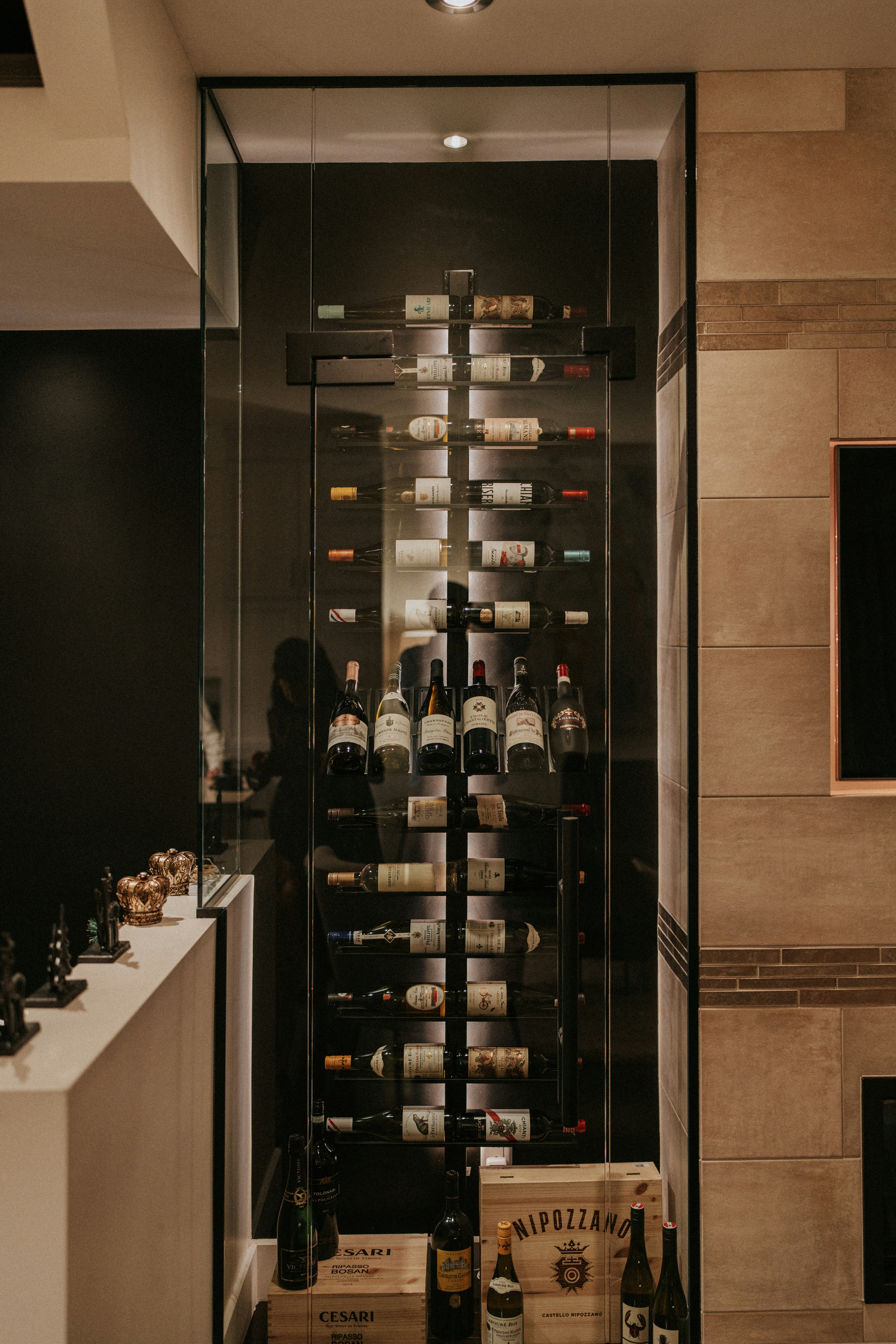 A room with a wine rack in the middle of it photo – Free Woman Image on ...