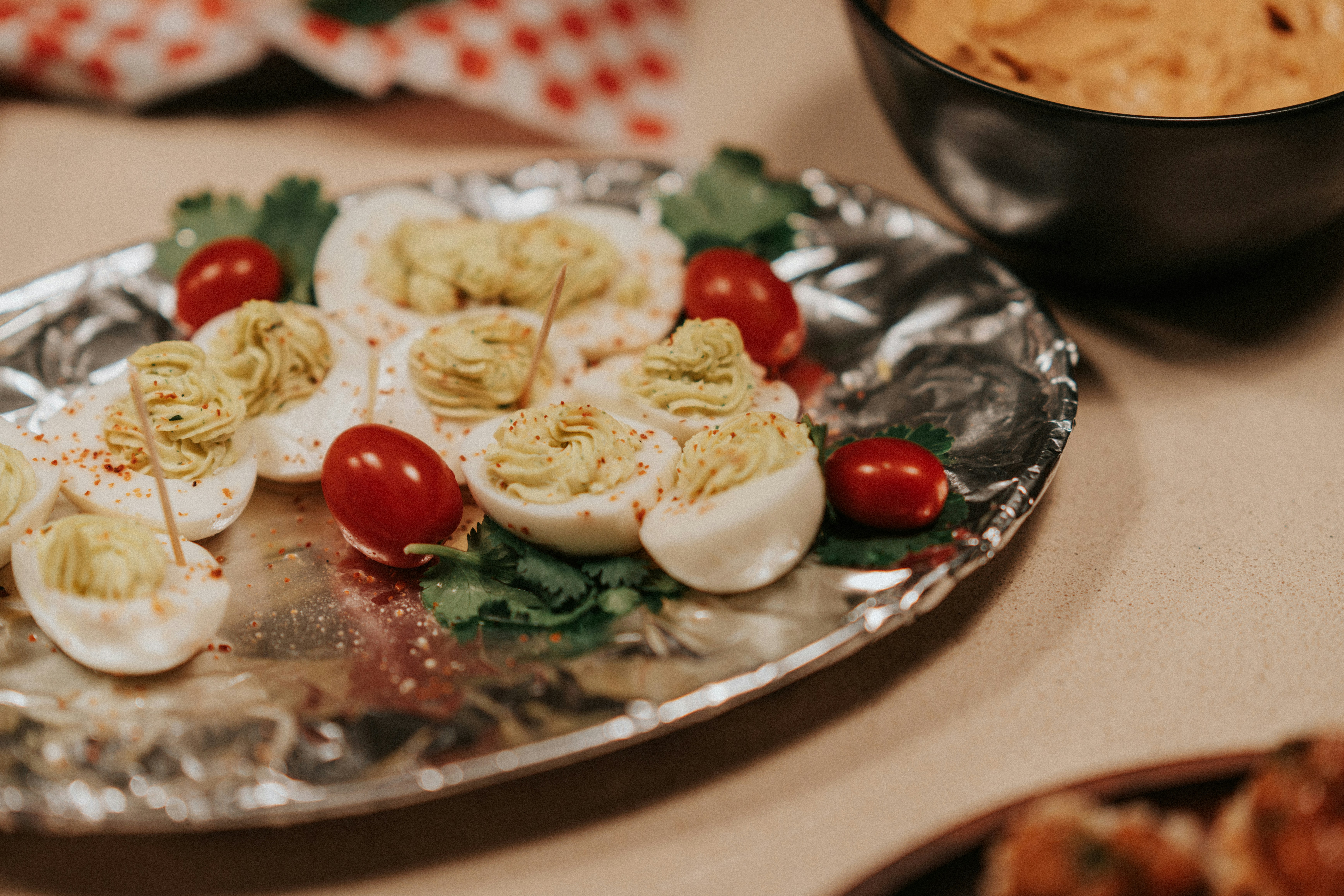 Creamy Peaks on a Reflective Plate: Deviled Eggs with Cherry Garnish