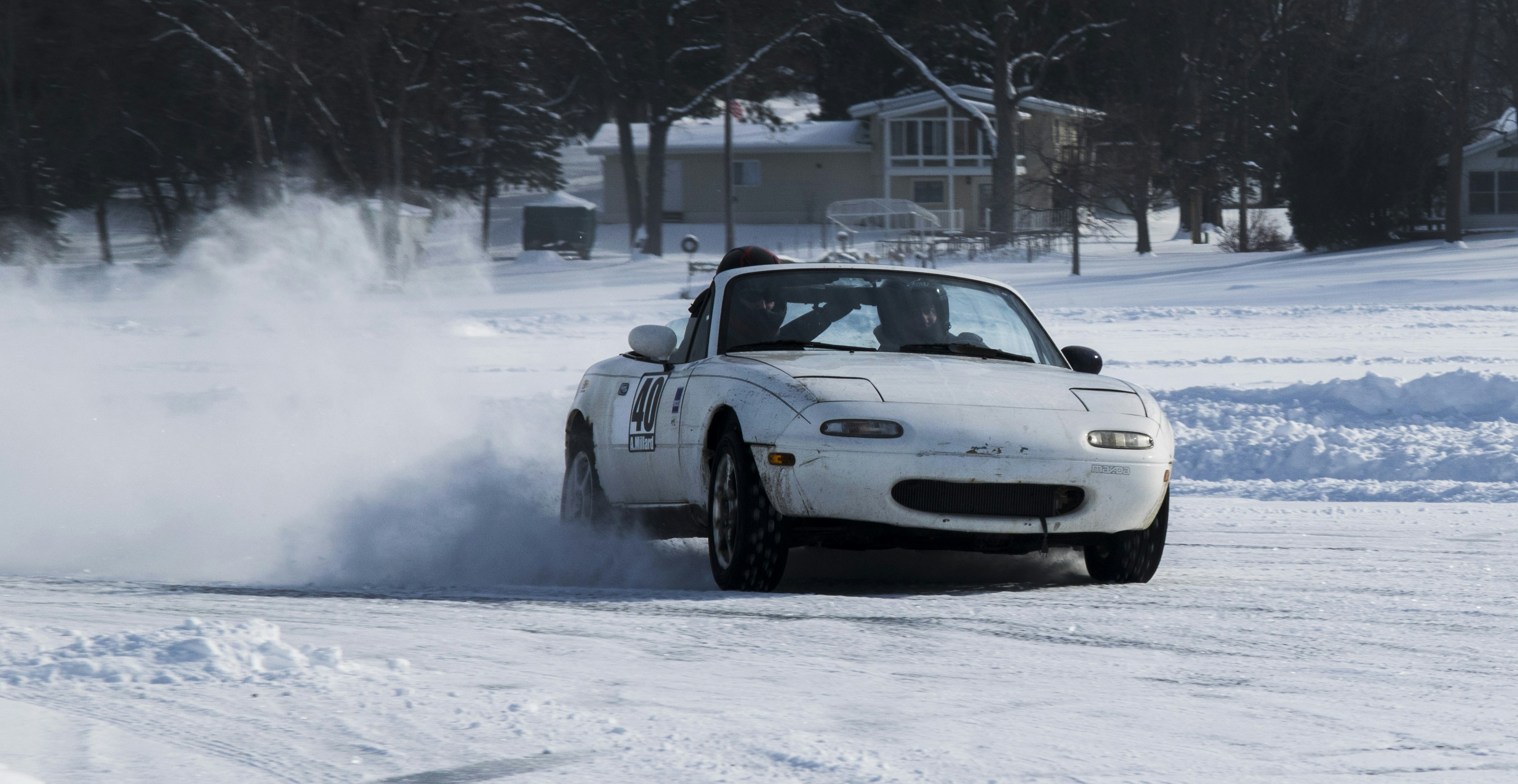 Snowbound Drift: A White Mazda Car Powers Through a Snowy Track