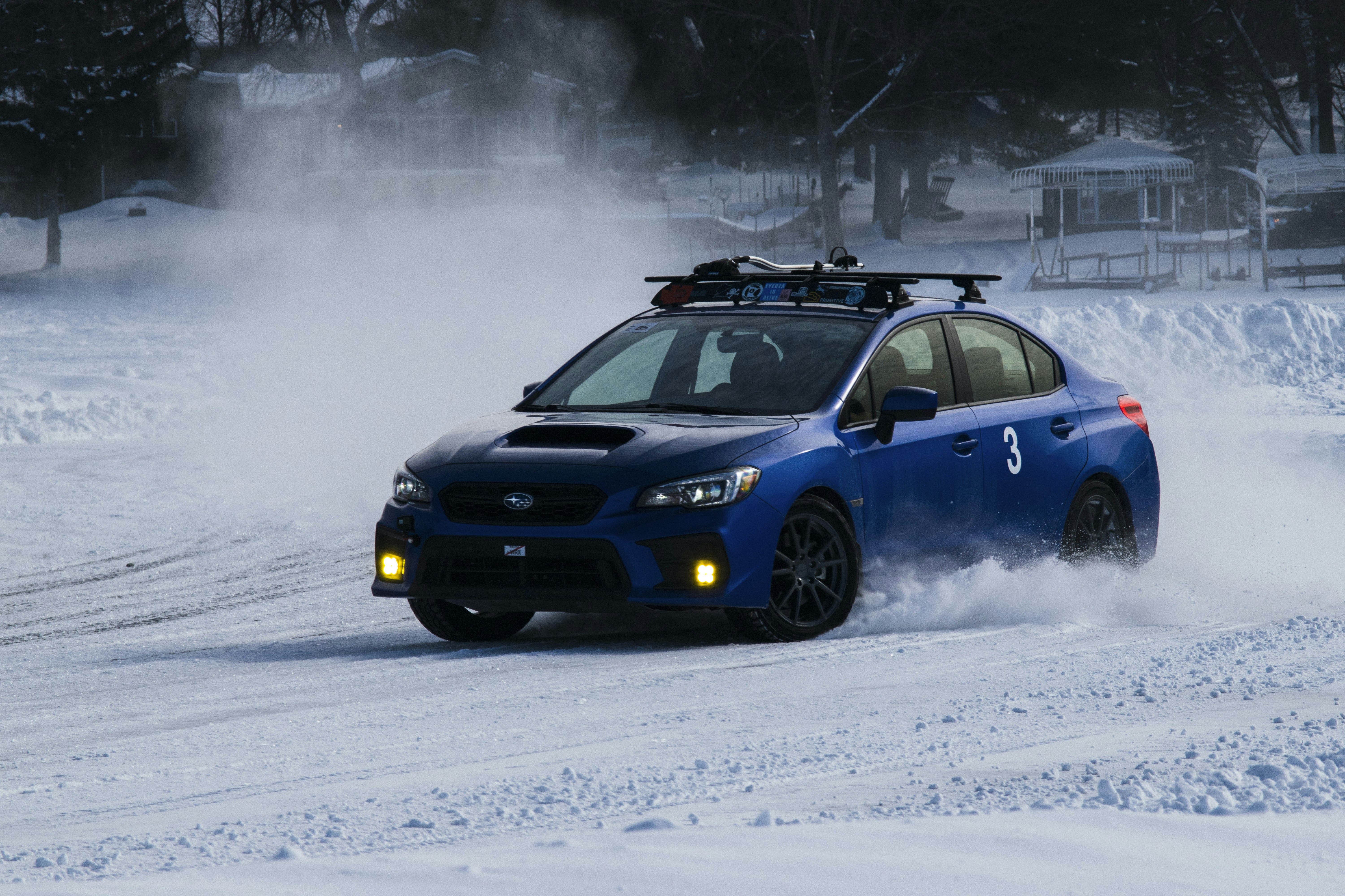 Powder-Spray Drift: Blue Subaru Rally Car Conquers a Snowy Track