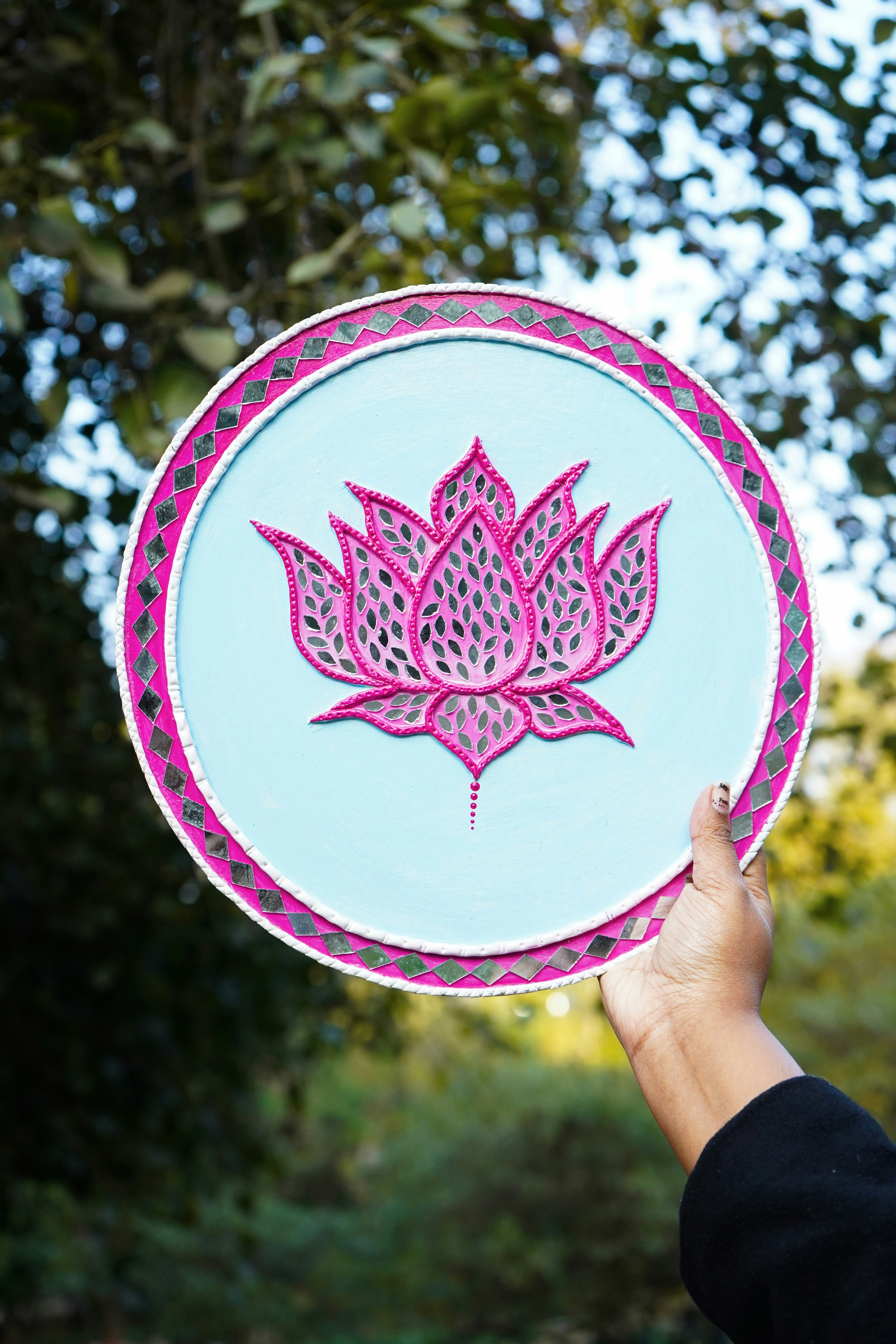 Handheld Pink Lotus Plate: A Bold Pop of Color in Dappled Garden Light