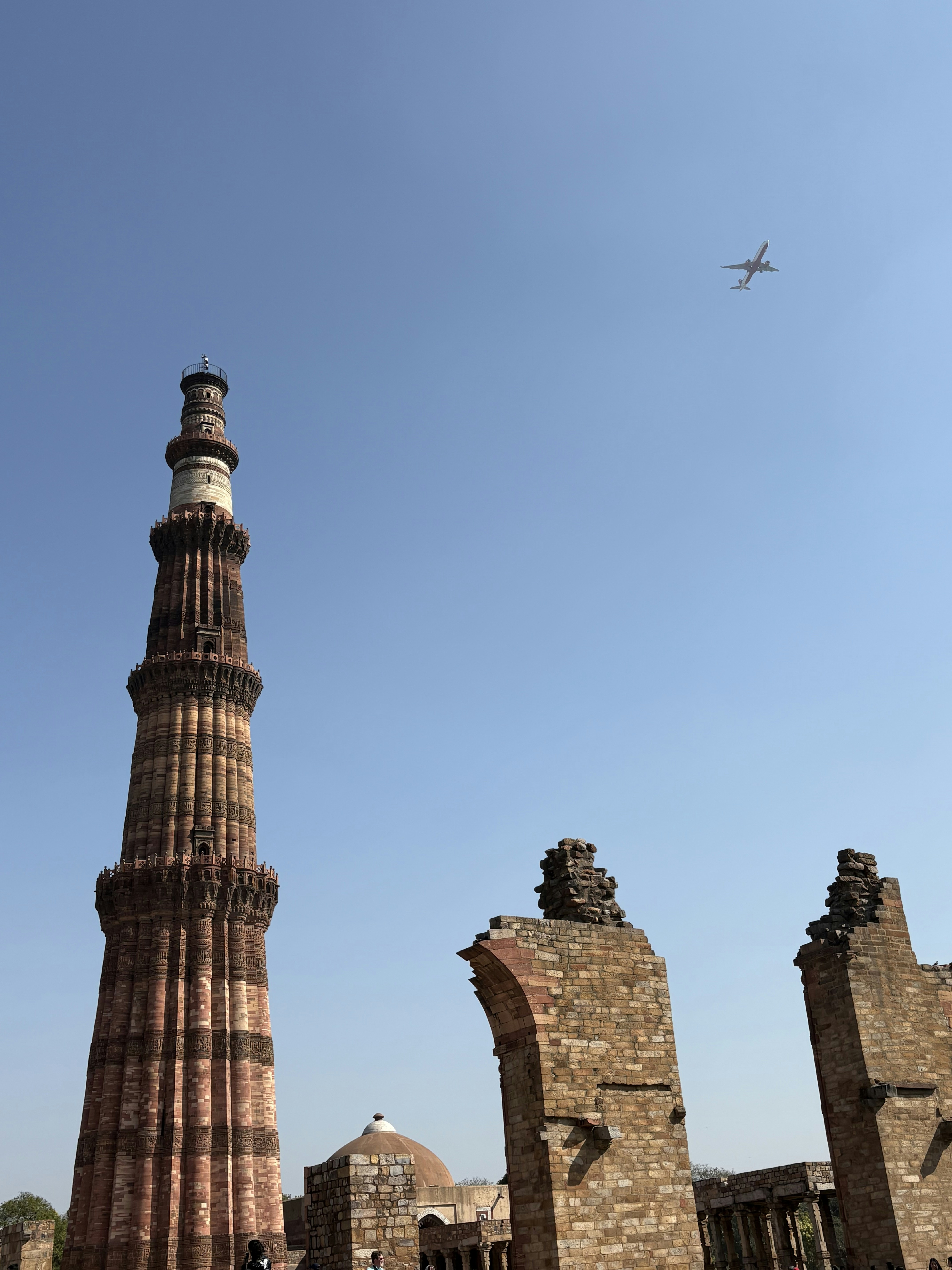 Qutub Minar among Ruins under a Cerulean Sky