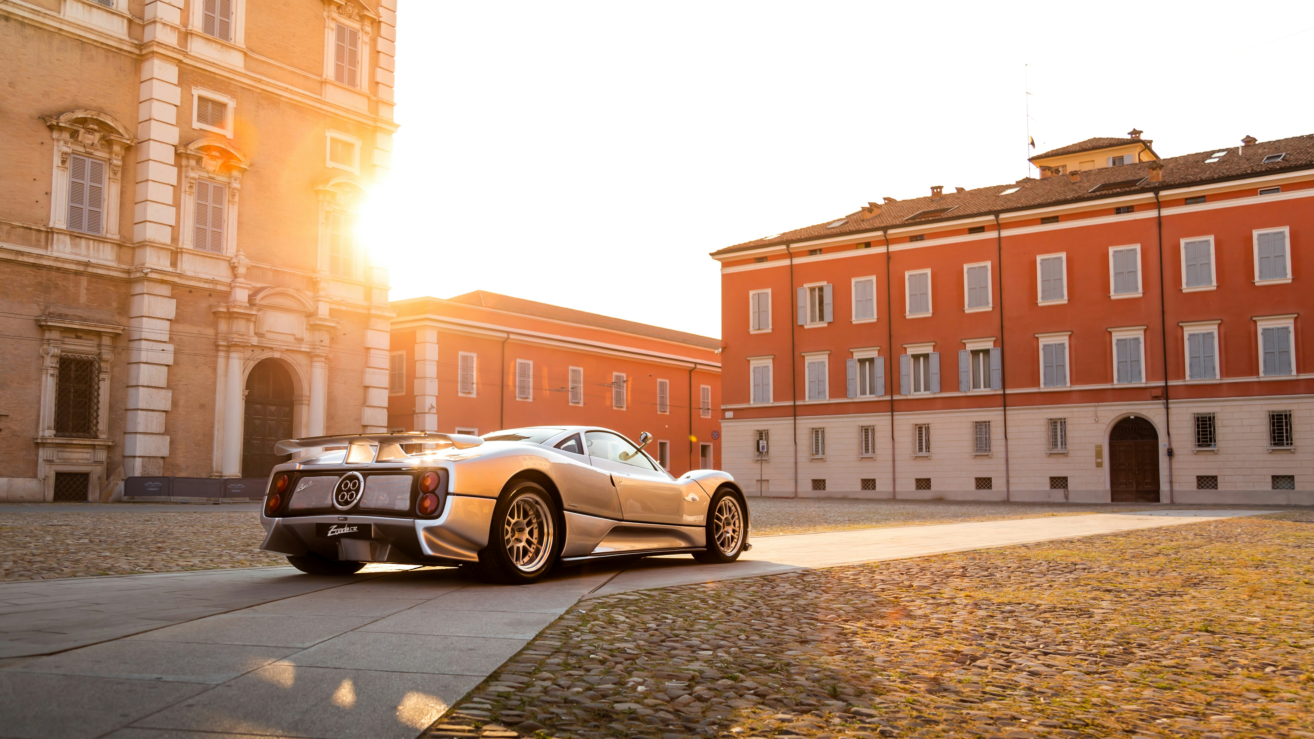 A car is parked in front of a building photo – Free Supercar Image on ...
