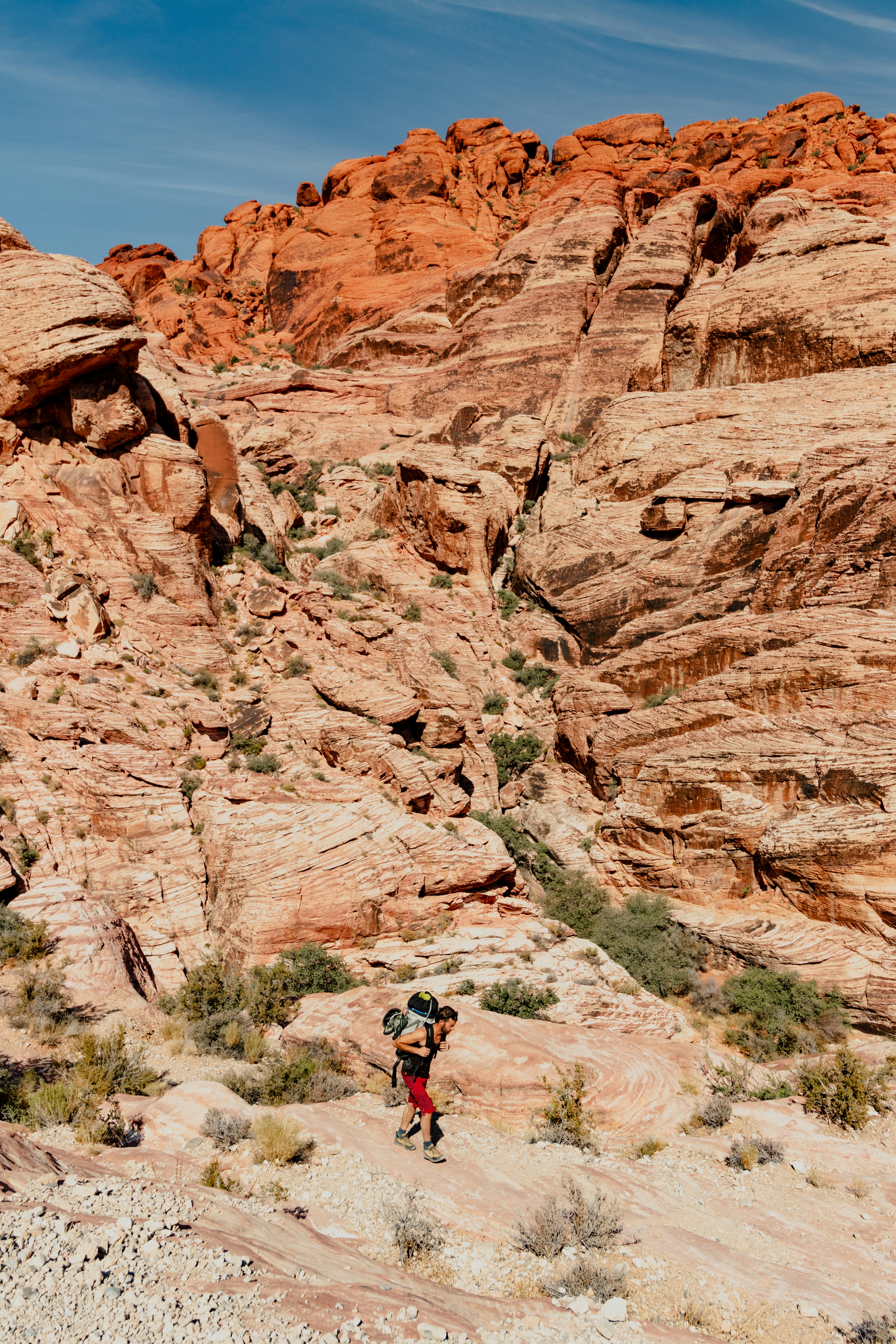 A man hiking up a mountain in the desert photo – Free Natural Image on ...