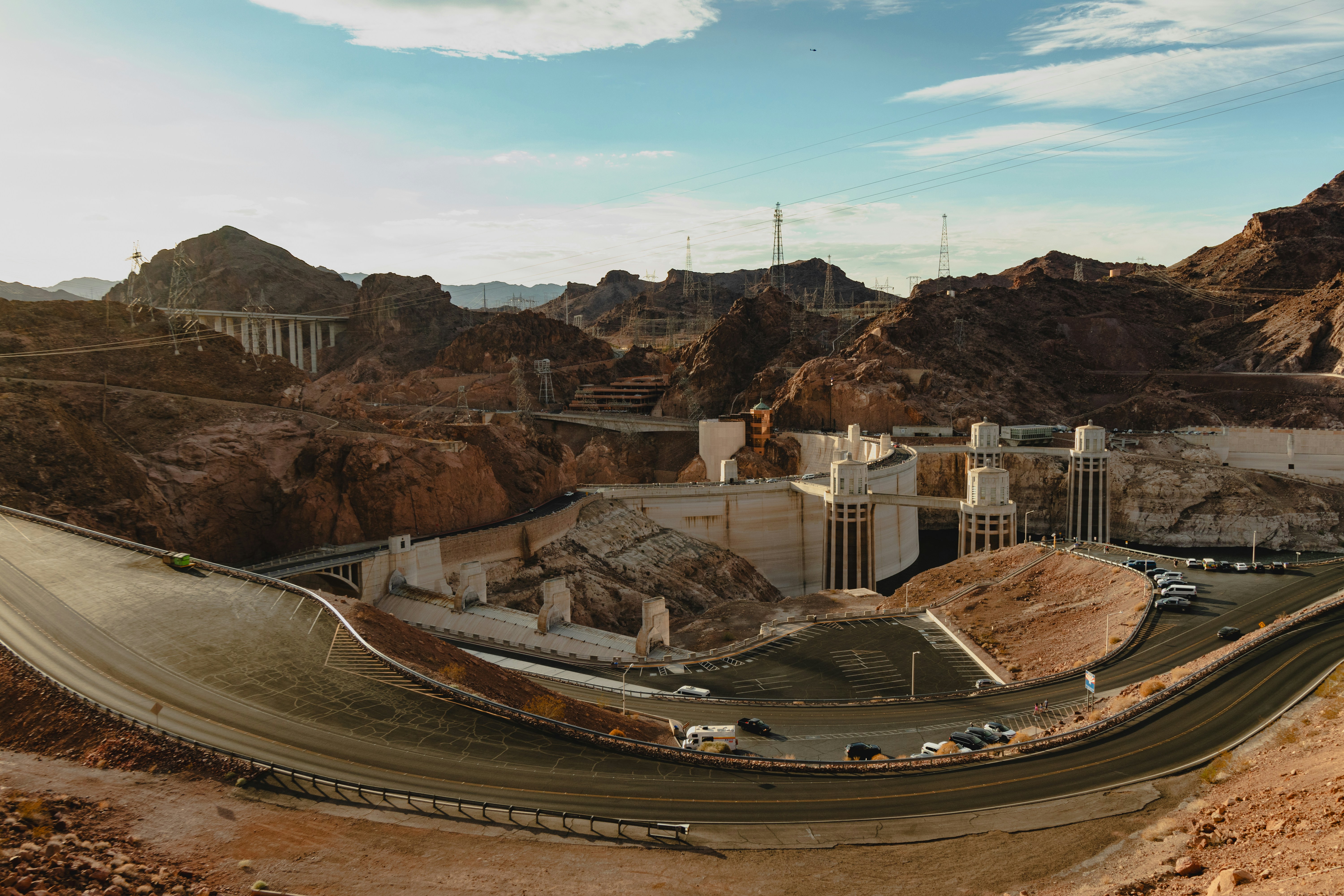 Hoover Dam nestled in rugged desert terrain under a clear sky.