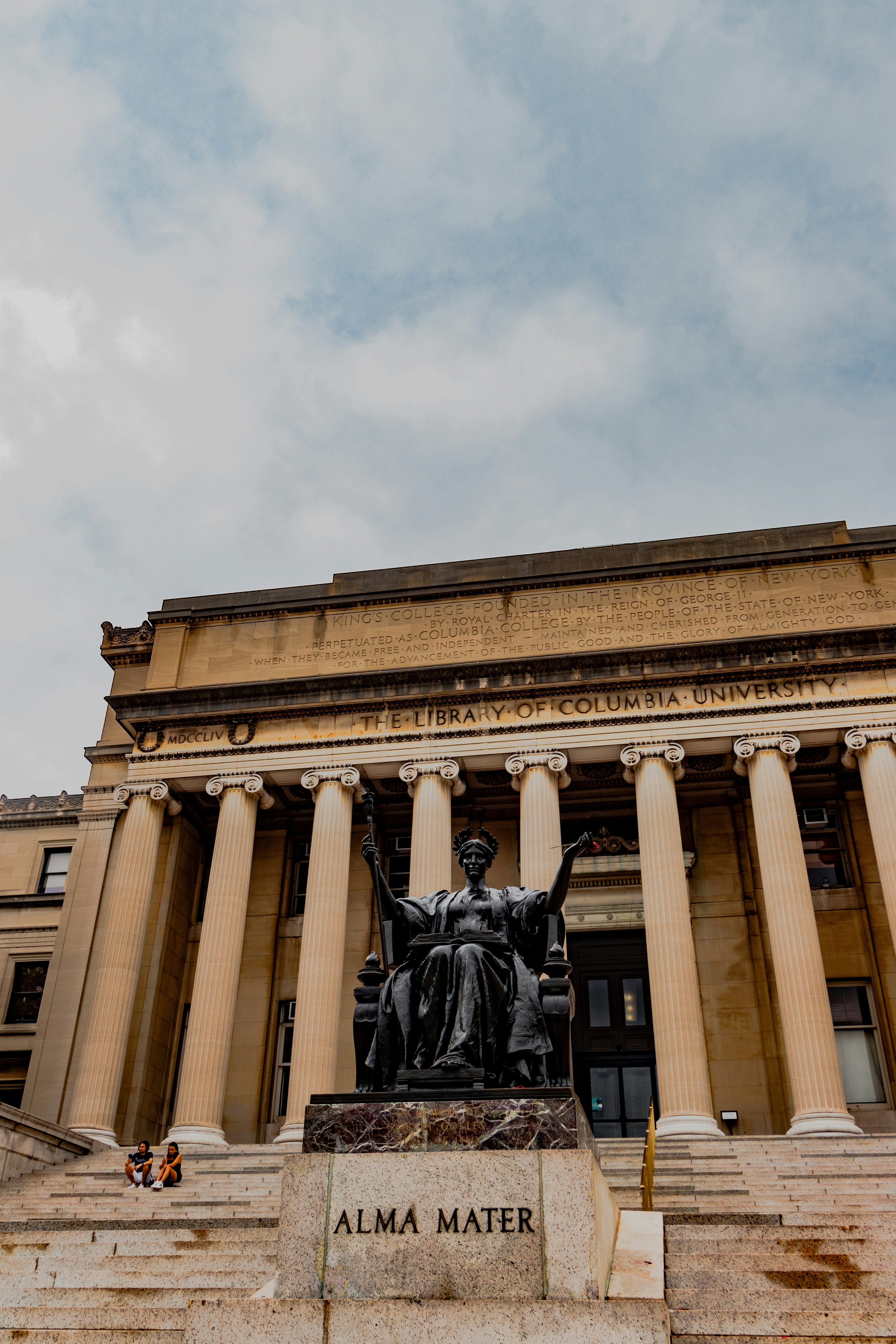 A building with columns and a statue in front of it photo – Free ...