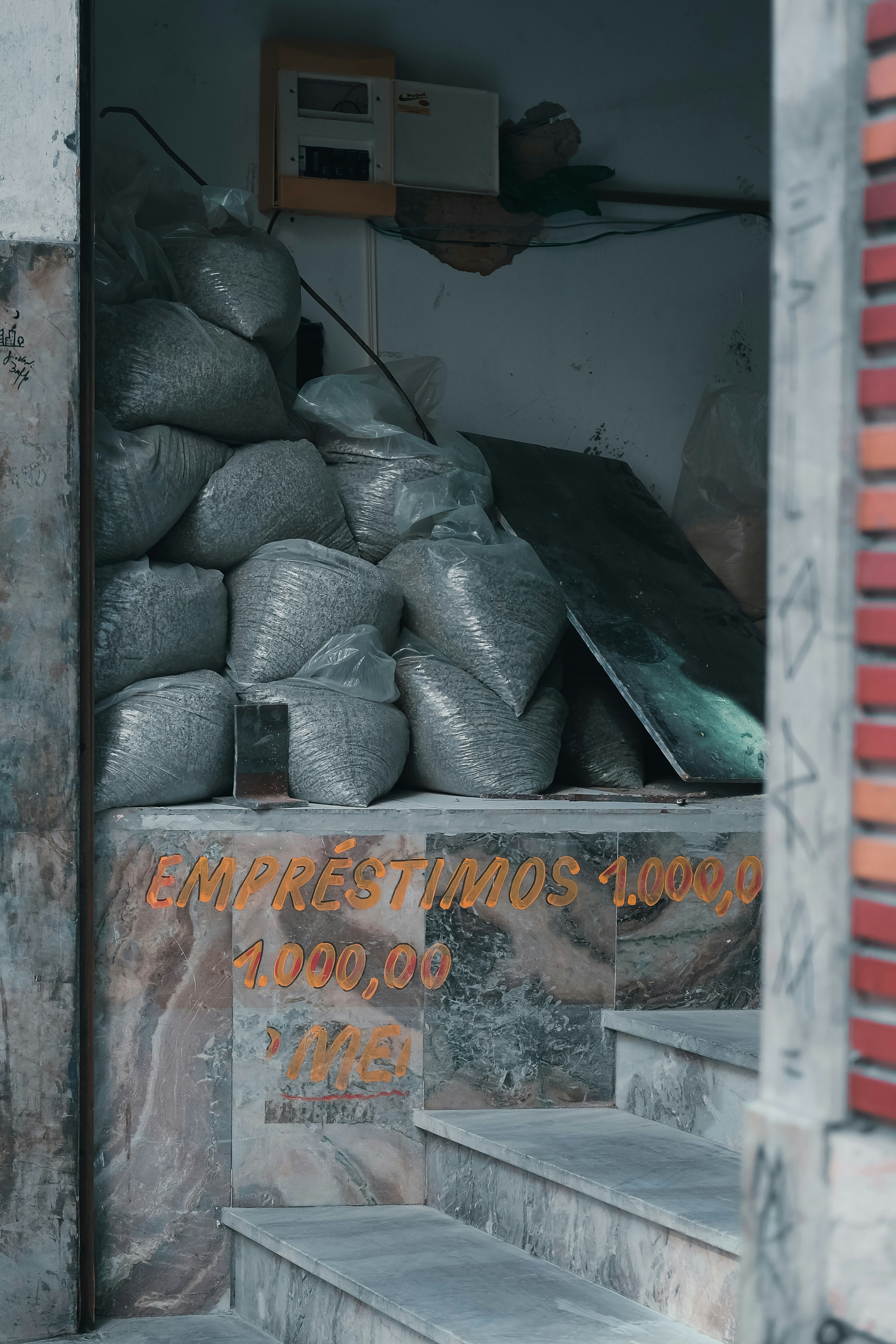 A bunch of bags of cement sitting on top of a set of steps photo – Free ...