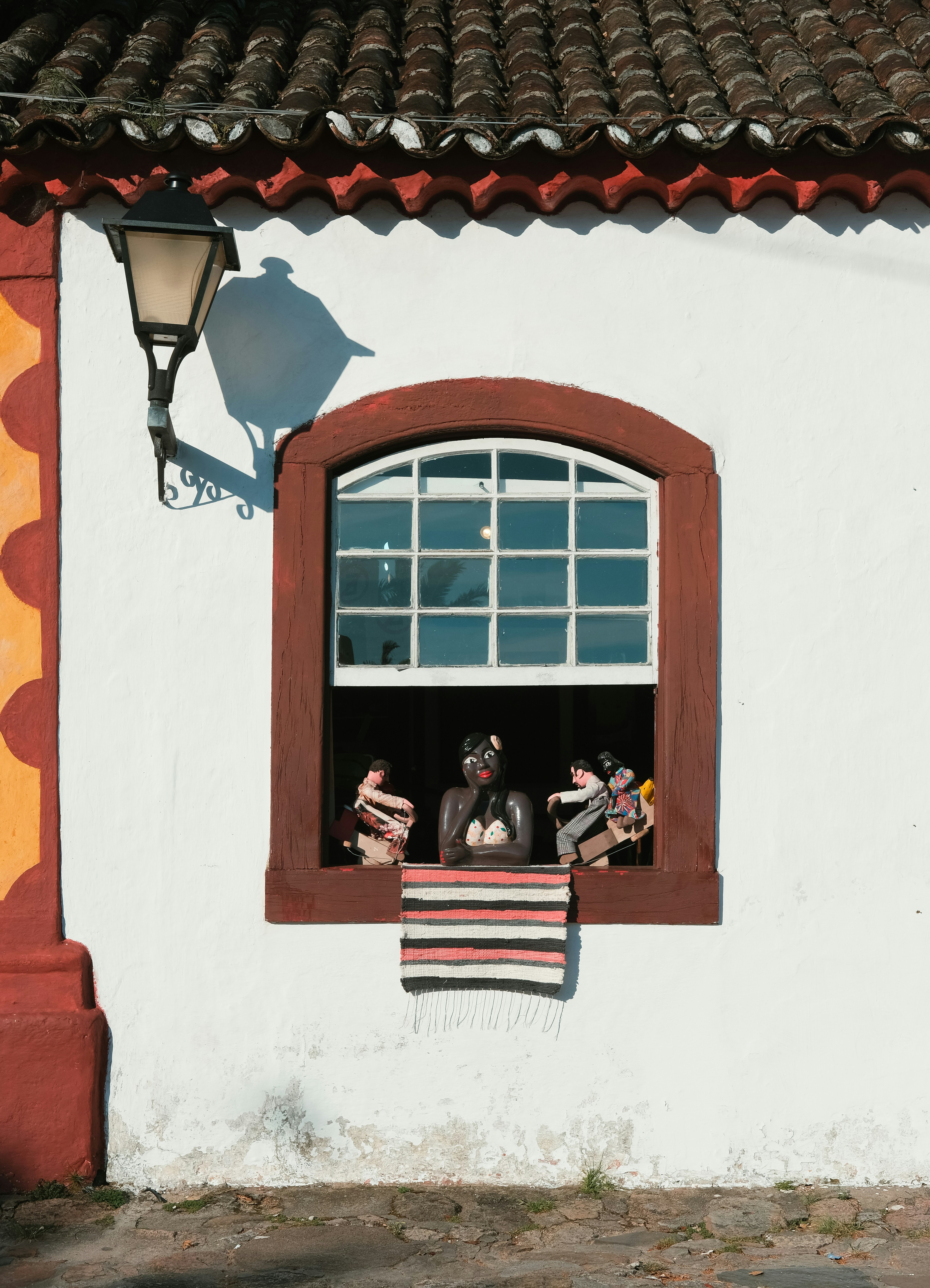Figurines at the Arched Window: Striped Rug and Lantern Shadow