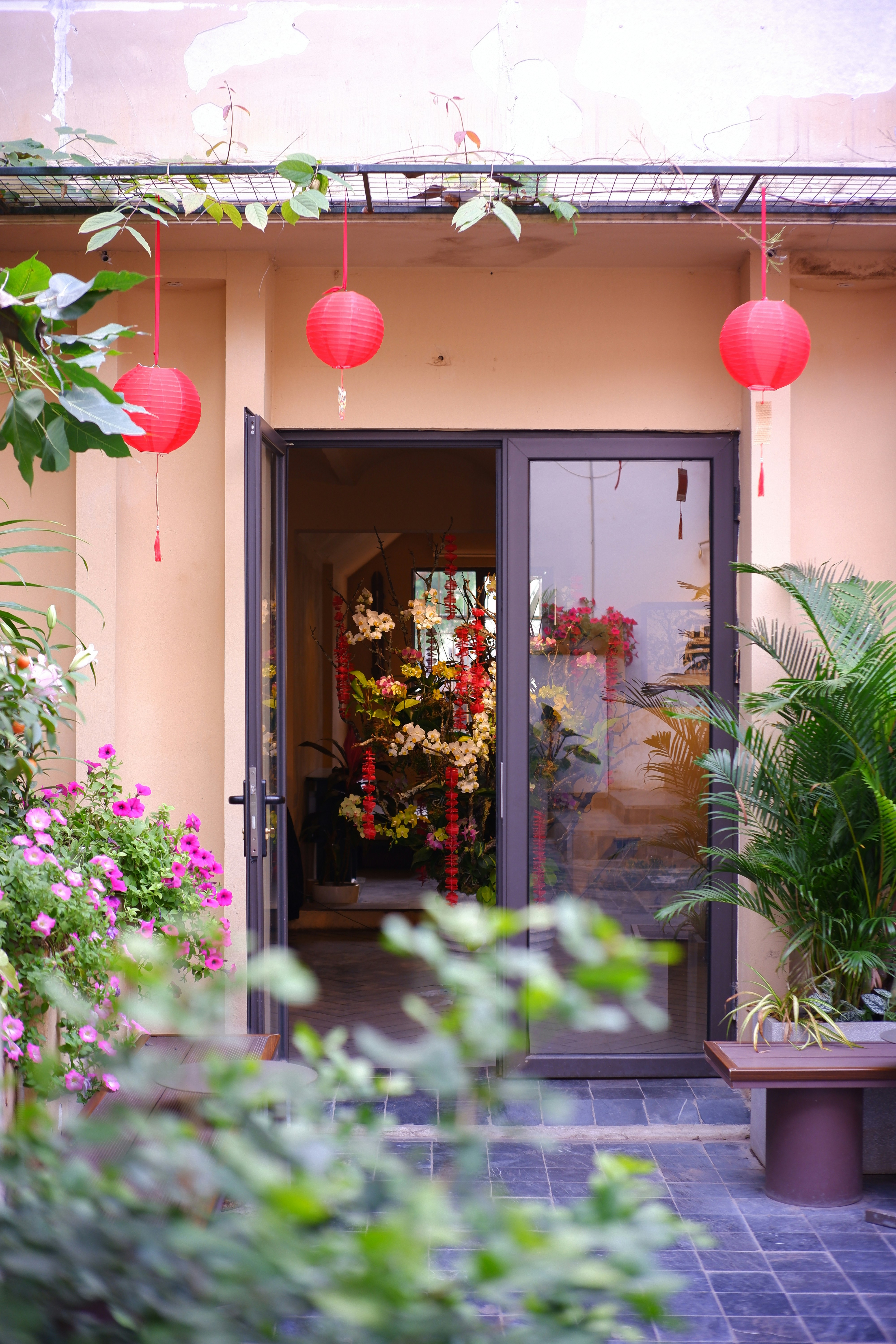 Open doorway to a blooming welcome: festive lanterns frame a floral interior