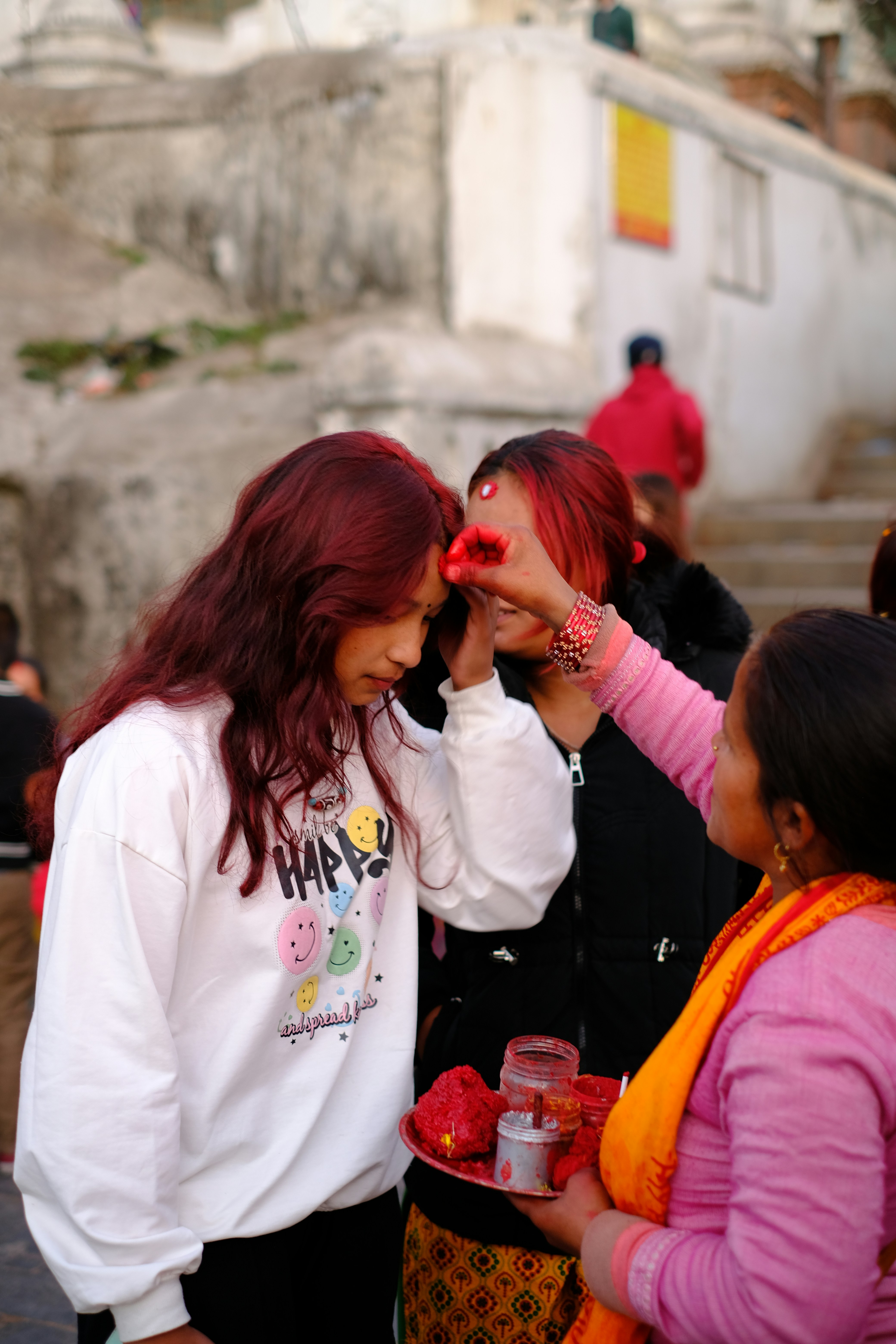 Crimson Exchange: Holi Moment Amid Color and Conversation