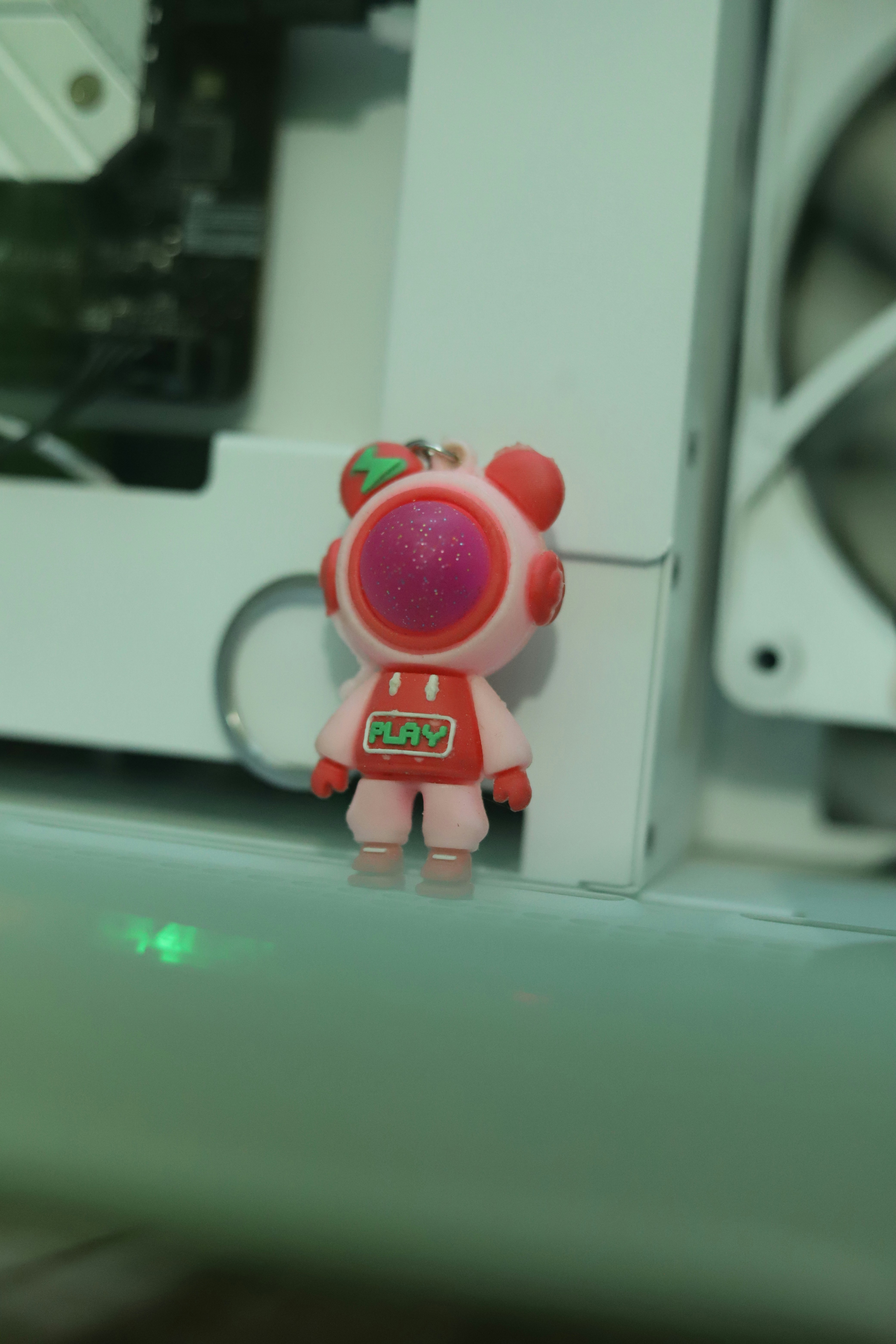 Tiny Pink Astronaut Guards a Quiet Machine