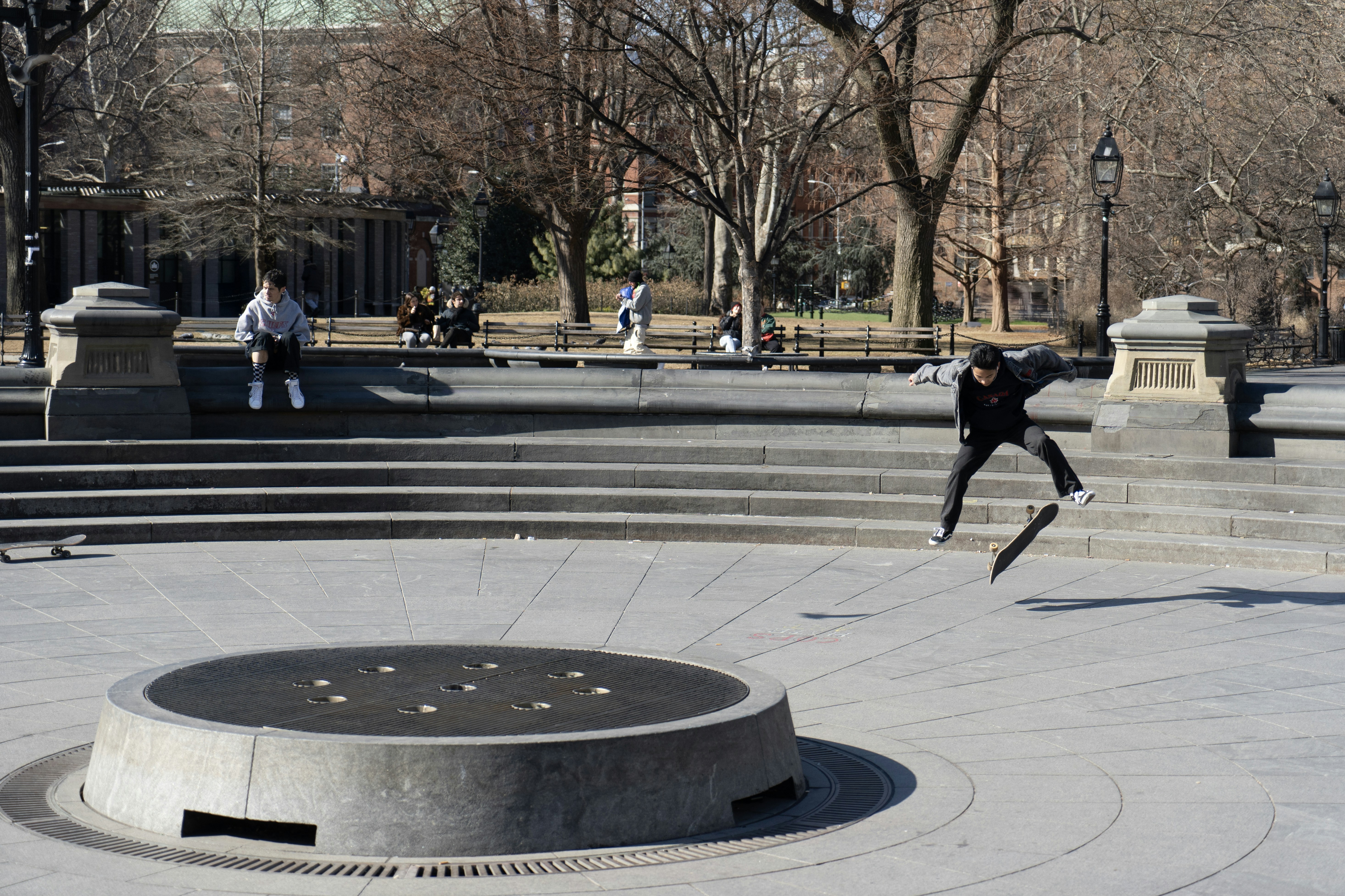 Urban Aerial: Skateboarder Soars in City Park