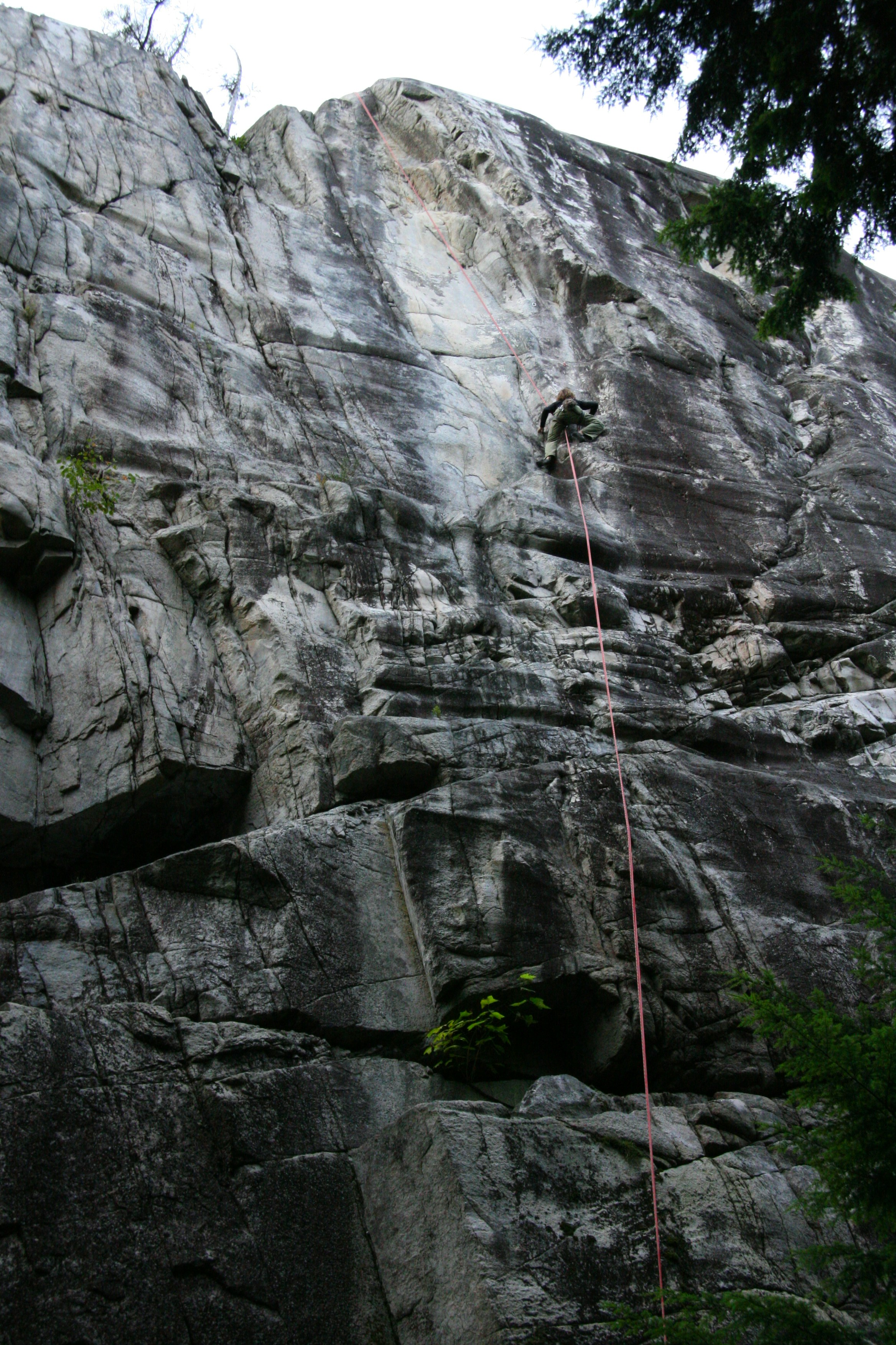 Crimson Rope, Granite Facade: A Lone Climber's Vertical Ascent