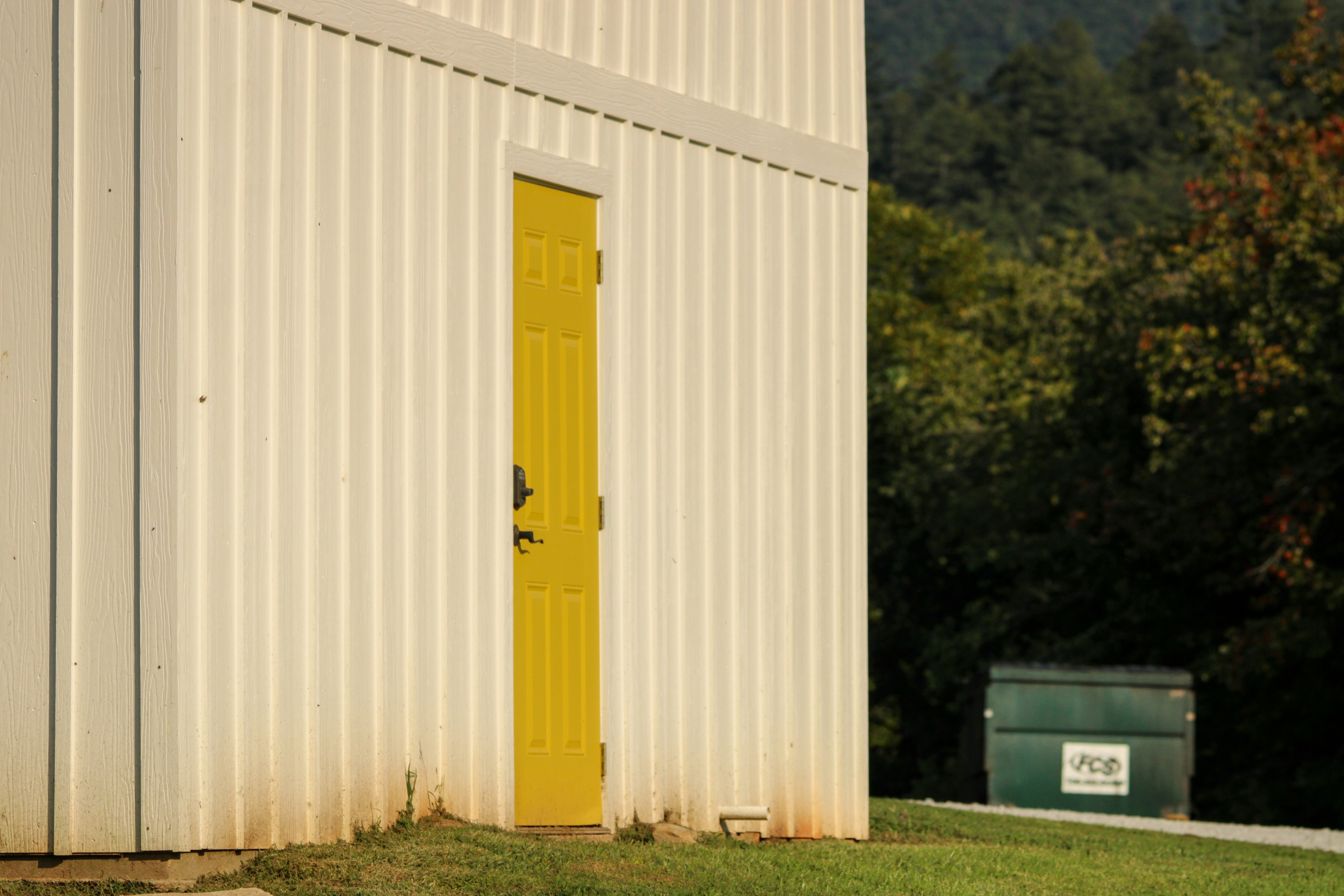 The Bold Yellow Door Framing a Quiet White Exterior