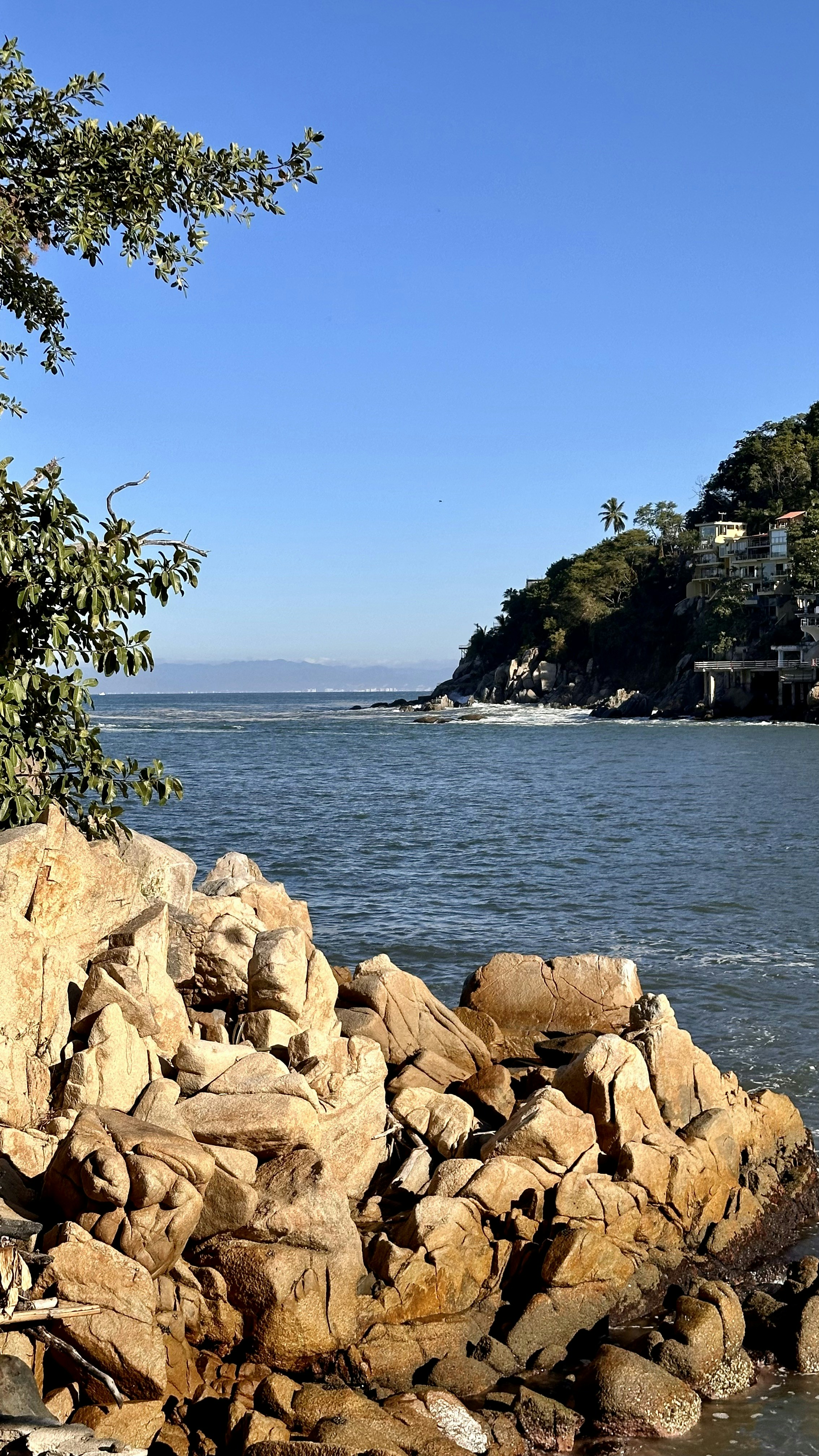 A large body of water surrounded by rocks photo – Free Messico Image on ...