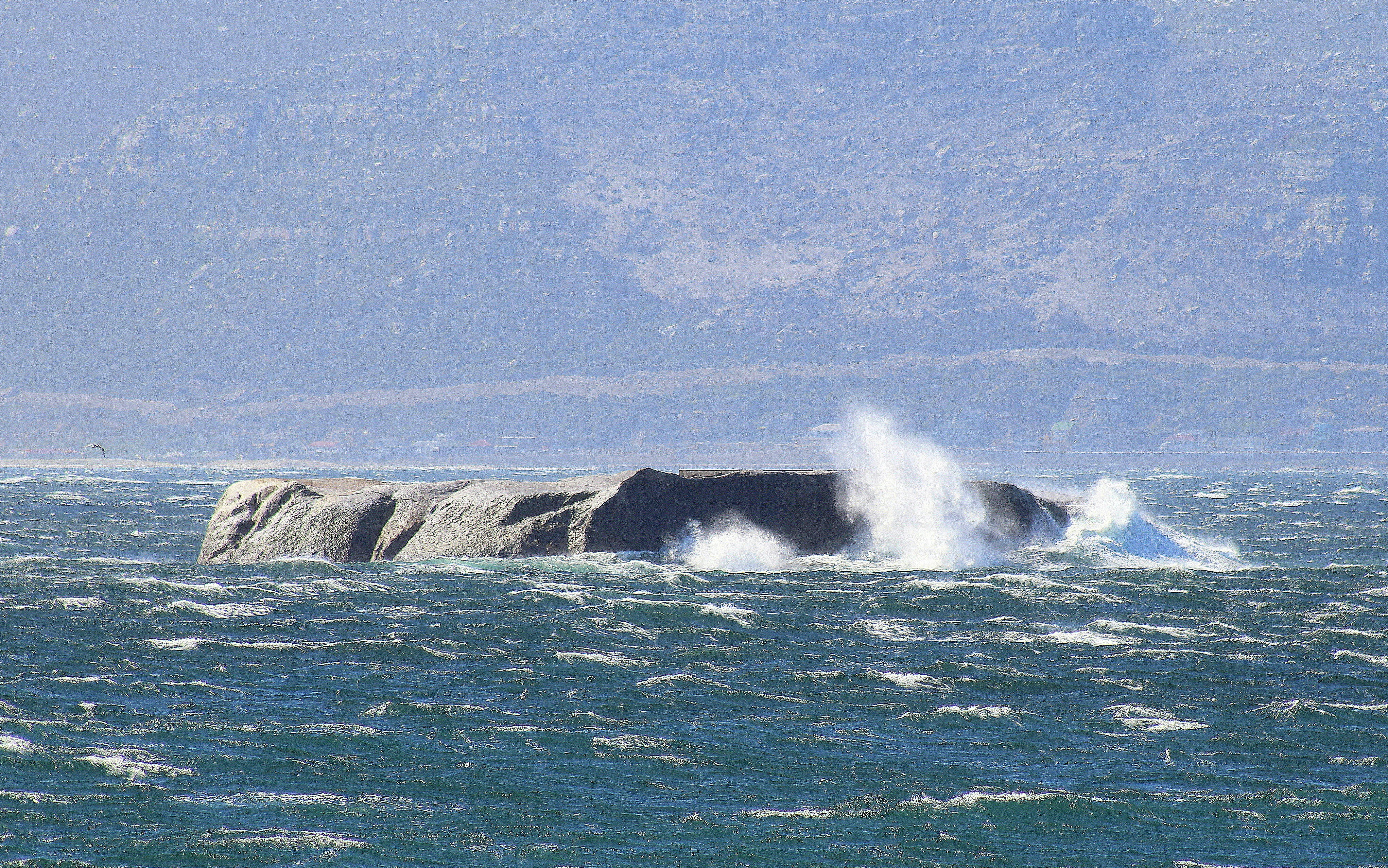 Breakers on the Granite Islet: Spray Arcs Over Weathered Rock