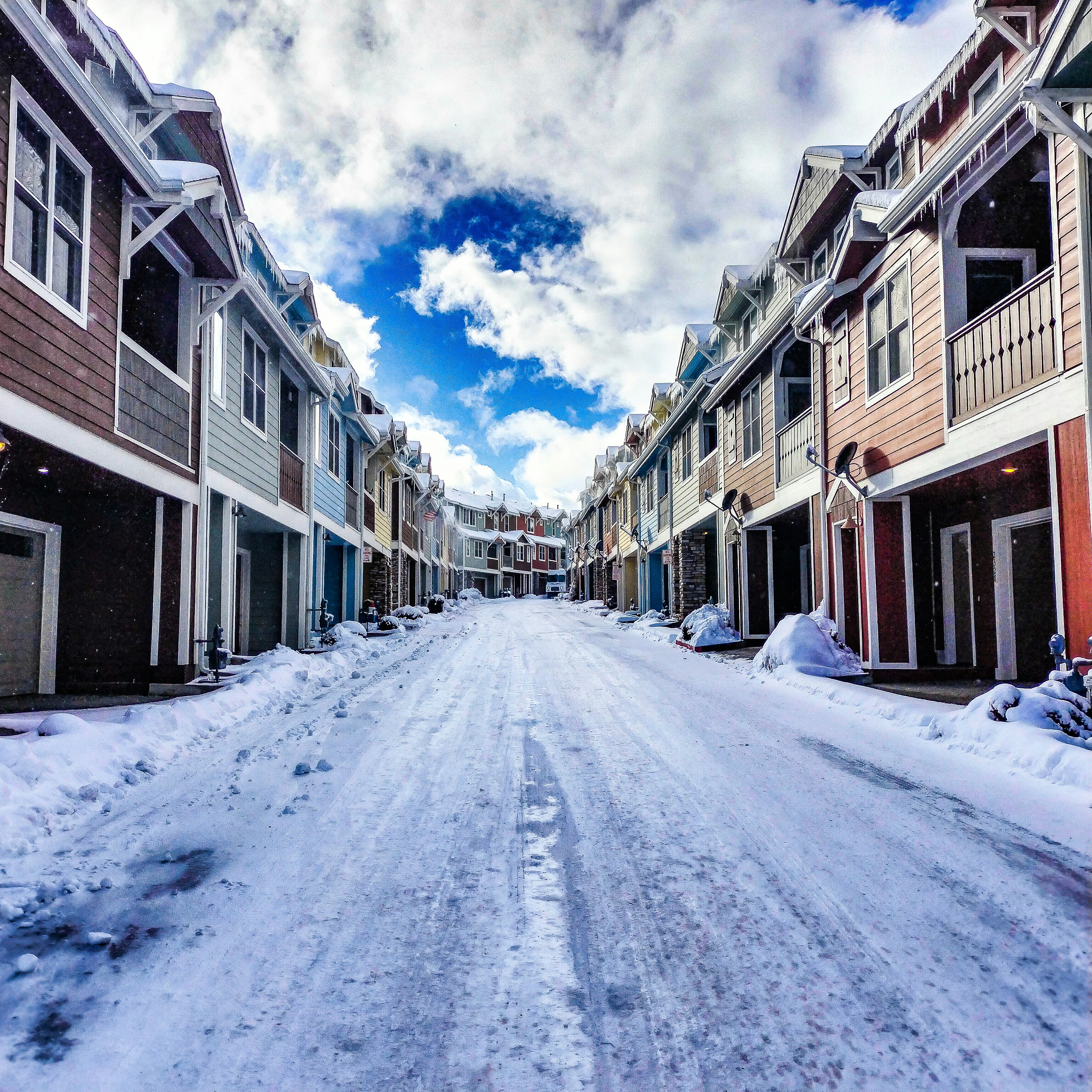 Winter Boulevard Between Row Houses Under a Blue Sky